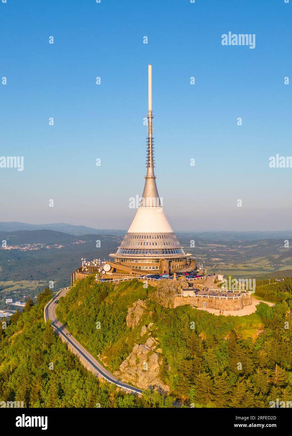 Sunny evening at Jested Mountain with unique building on the summit ...