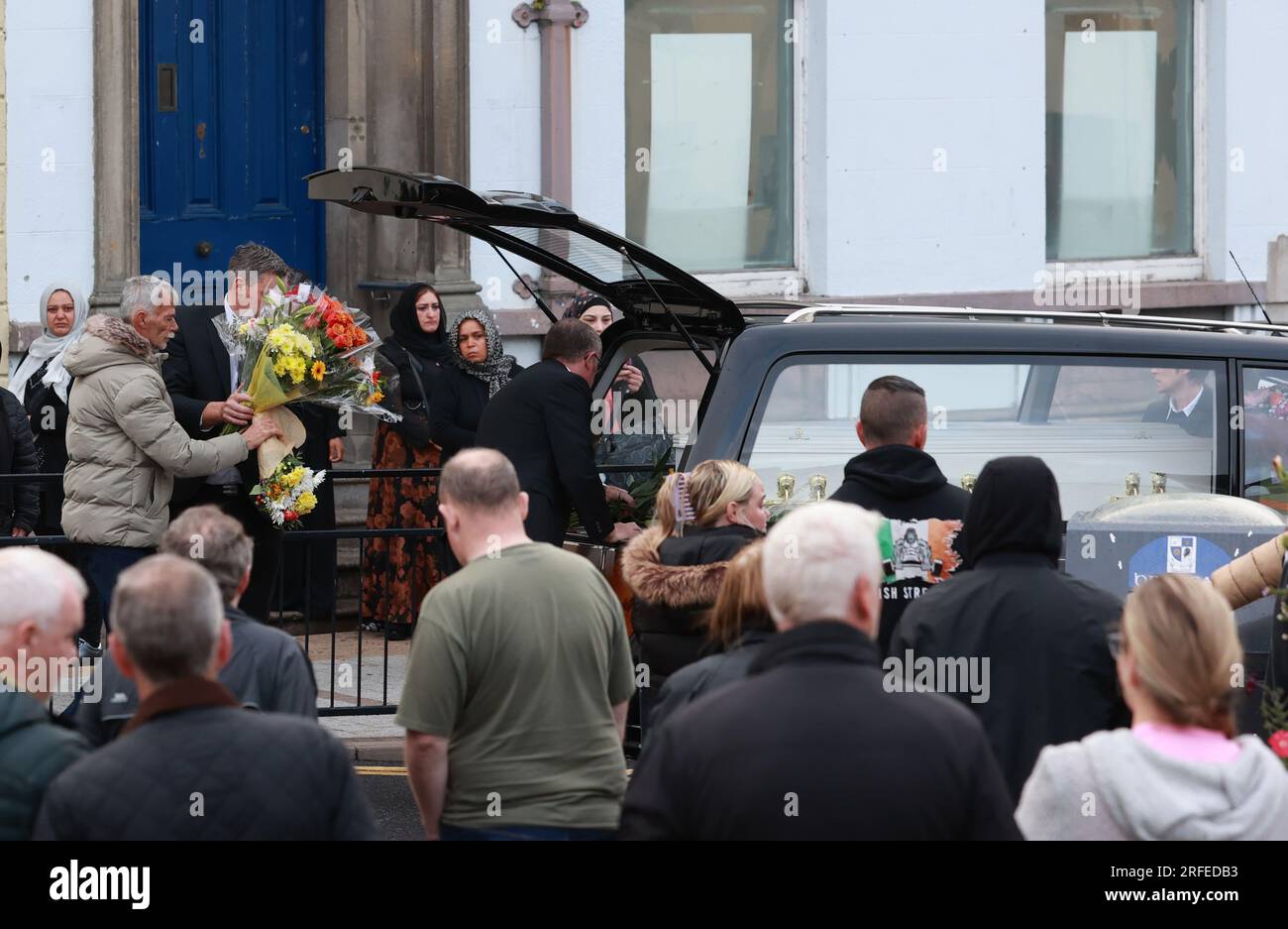 The coffin carrying Dlava Mohamed outside the family home in Clones, Co ...