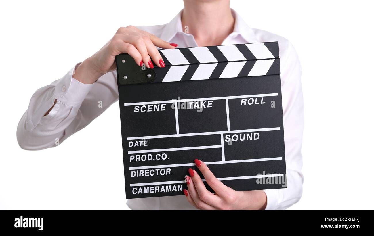 Woman pinches black clapboard and give signal for filming Stock Photo ...