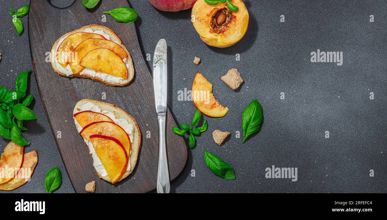 Fresh bread sandwiches with sweet peach slices, cream cheese and basil ...