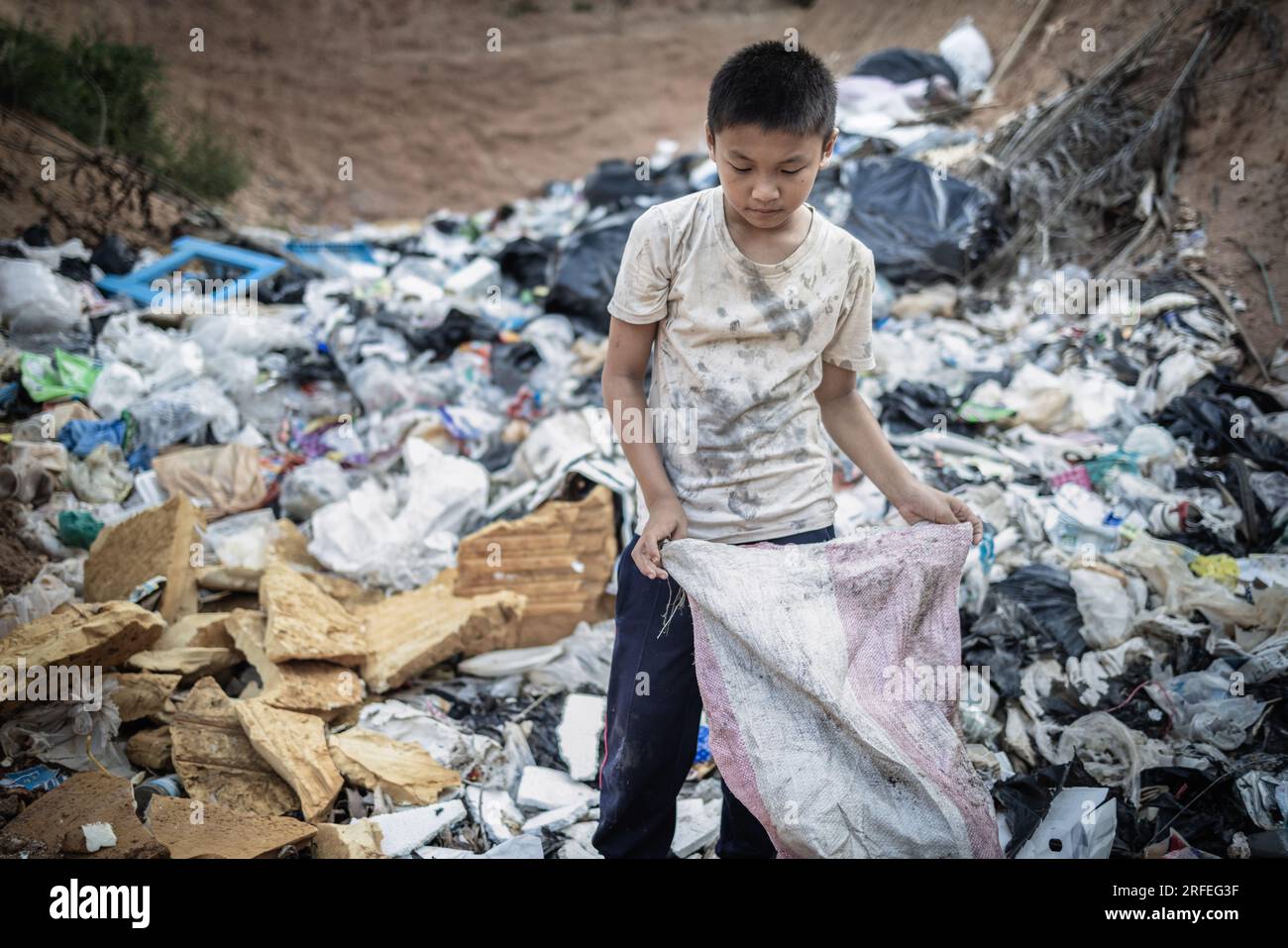 Child labor. Children are forced to work on rubbish. Poor children ...