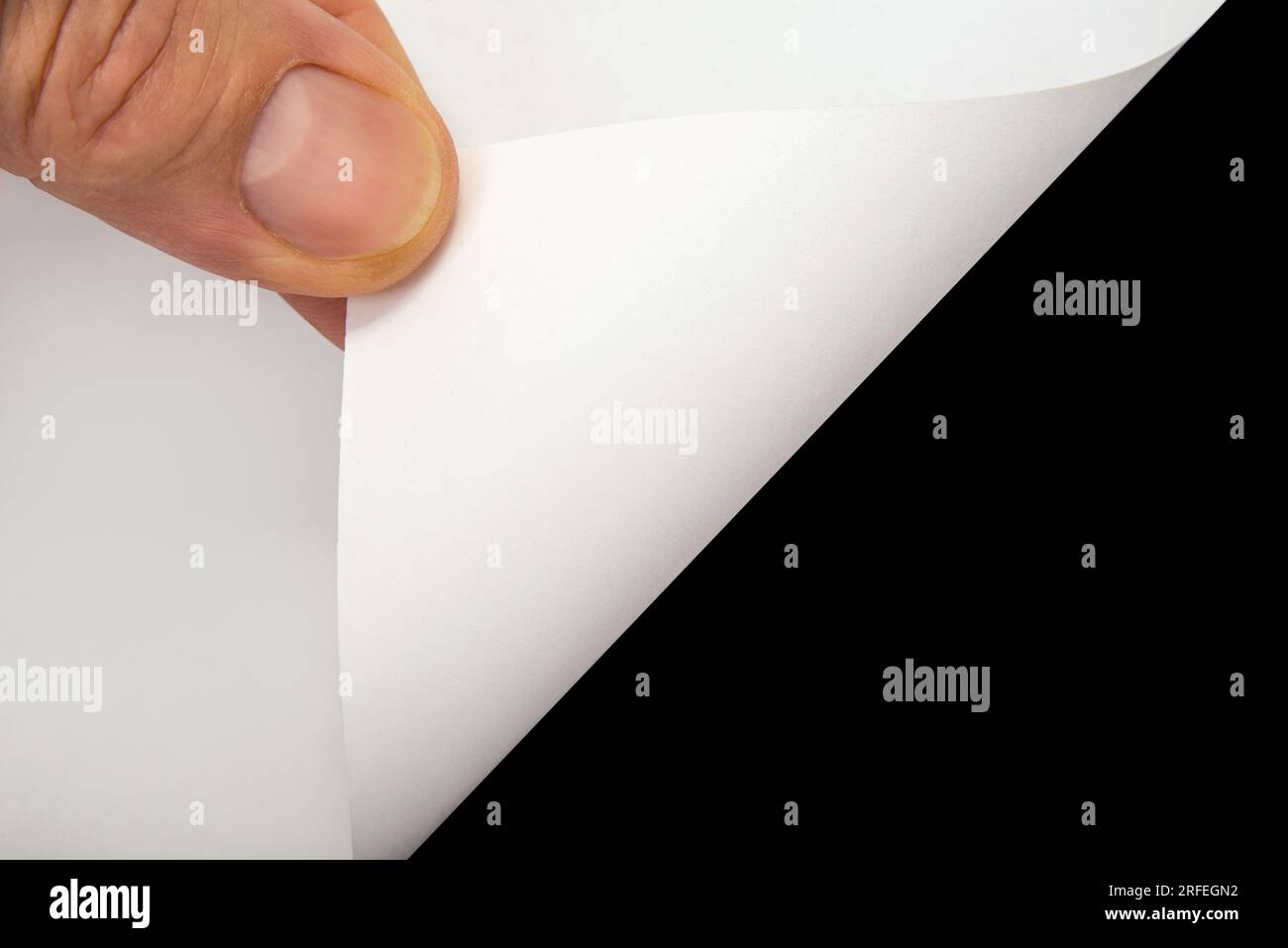 Hand pulling a paper corner to uncover, reveal something. Turn new page ...