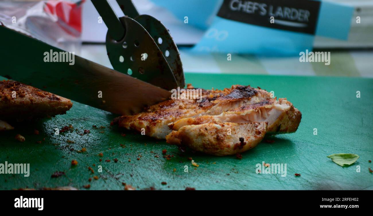 Grilled chicken being sliced Stock Photo - Alamy