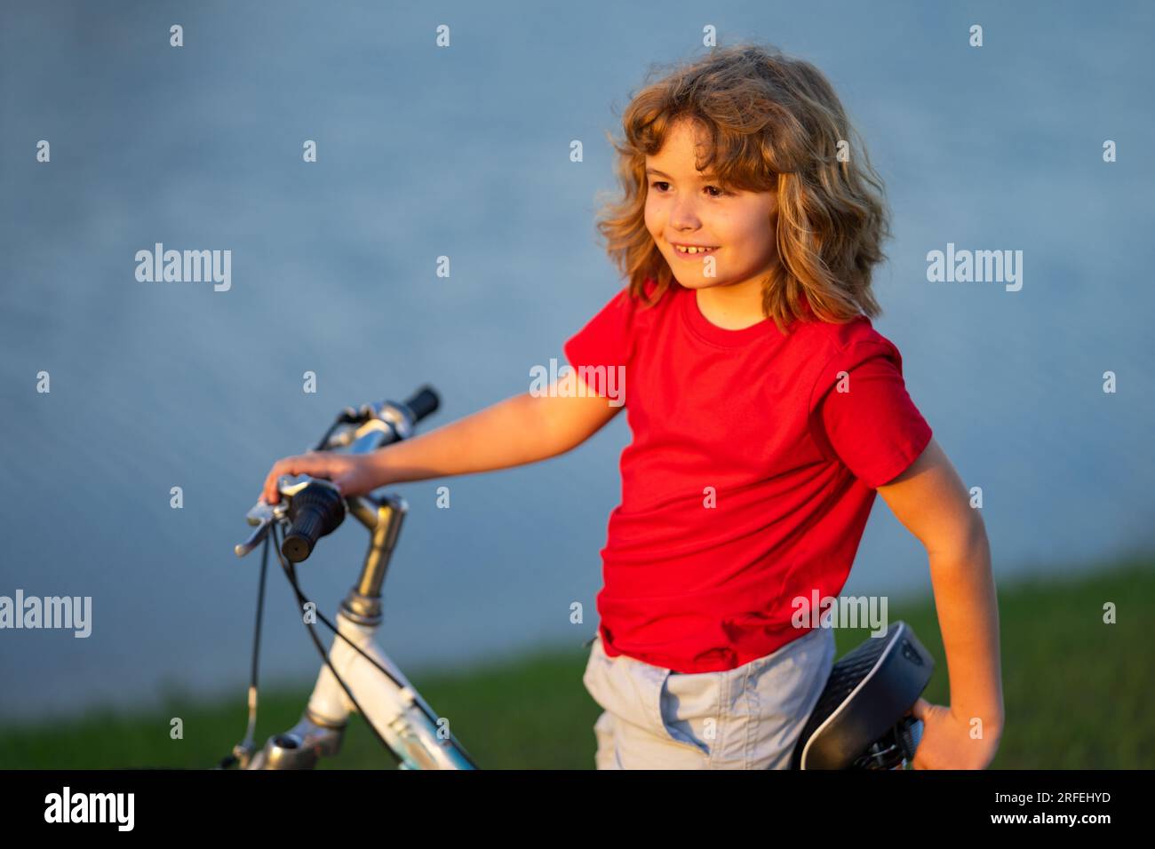 Little kid boy ride a bike in the park. Kid cycling on bicycle. Happy ...