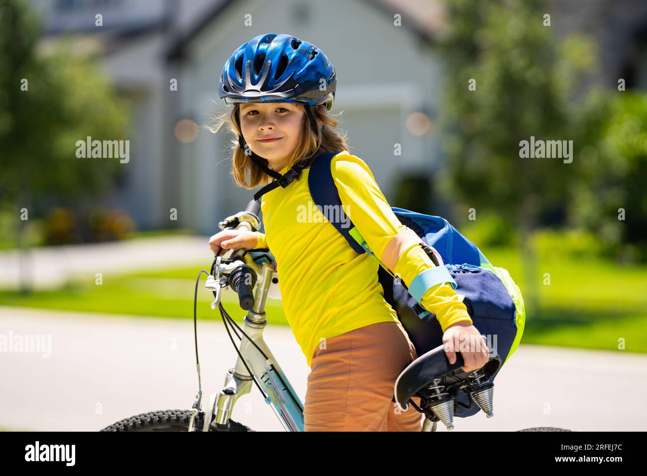 Kid riding bike in a helmet. Child riding bike in protective helmet ...