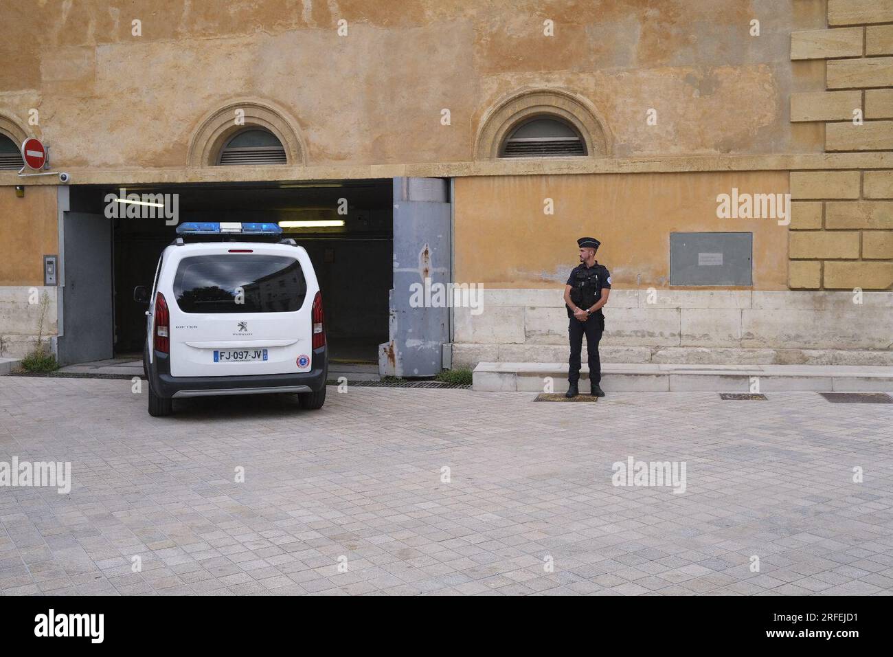 A French police officer stands guard as a detained police officer ...