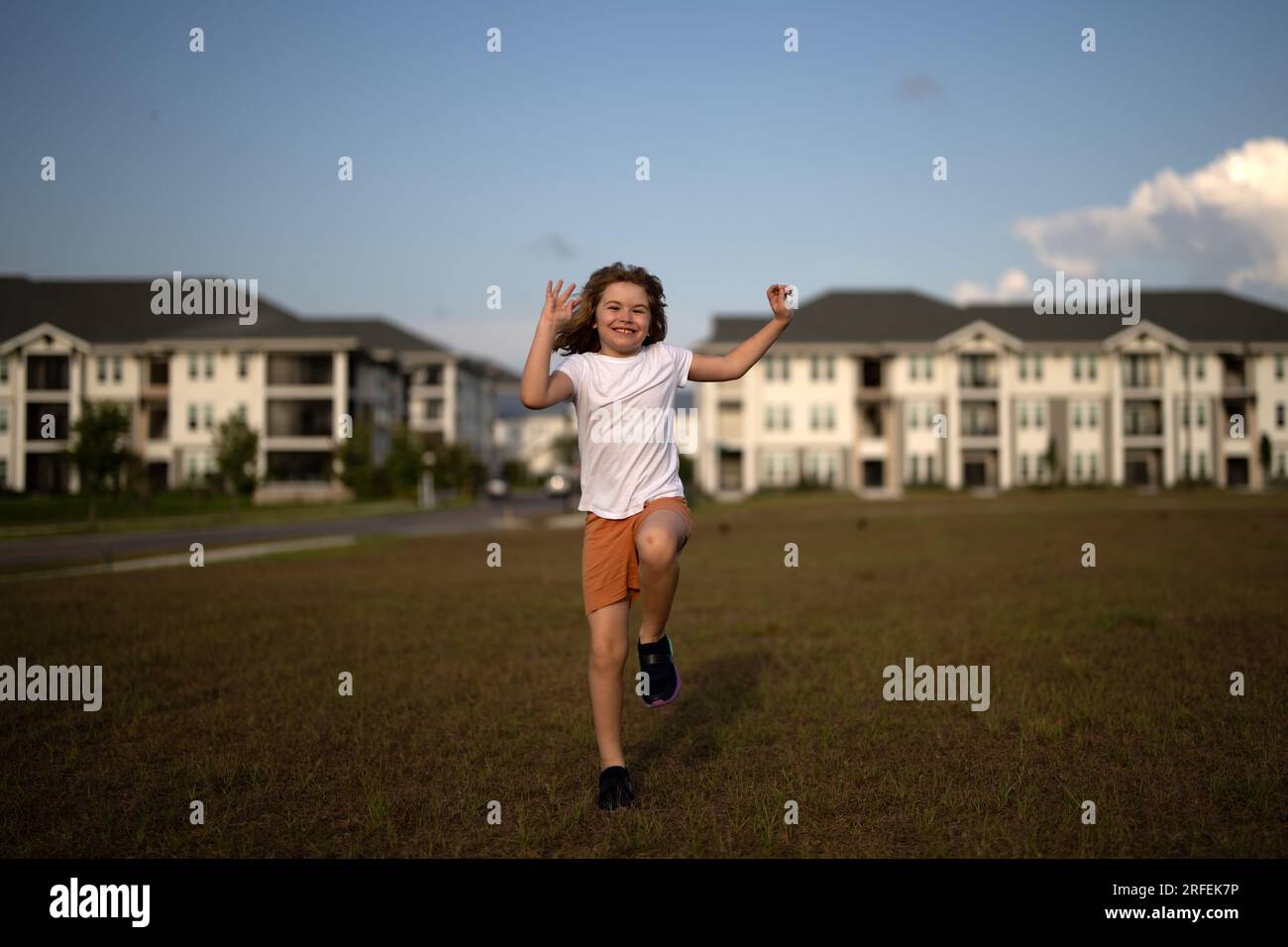 Child run. Excited kid boy running on grass. Kid boy playing and ...