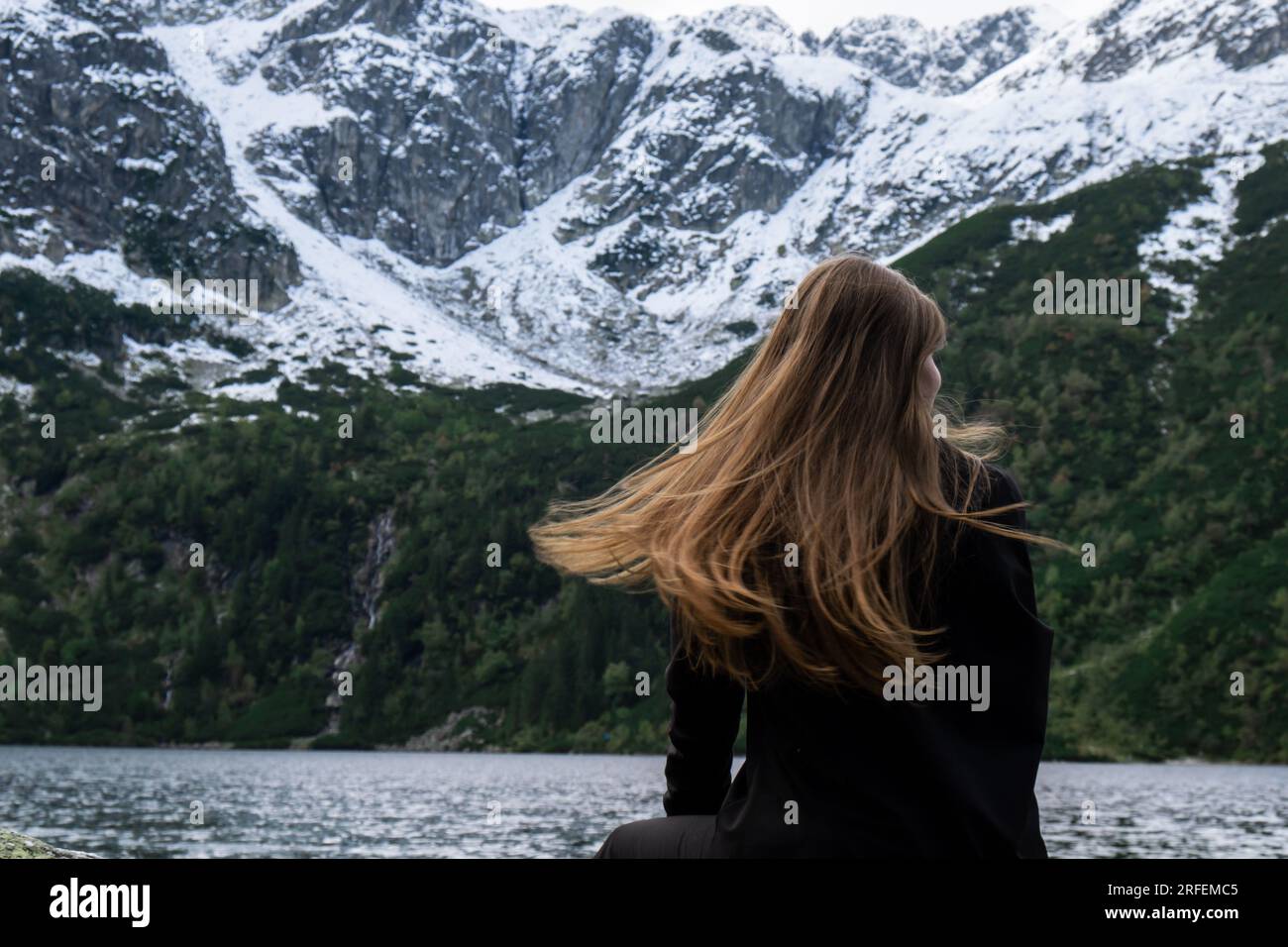 Young woman enjoying nature in Morskie Oko Snowy Mountain Hut in Polish ...