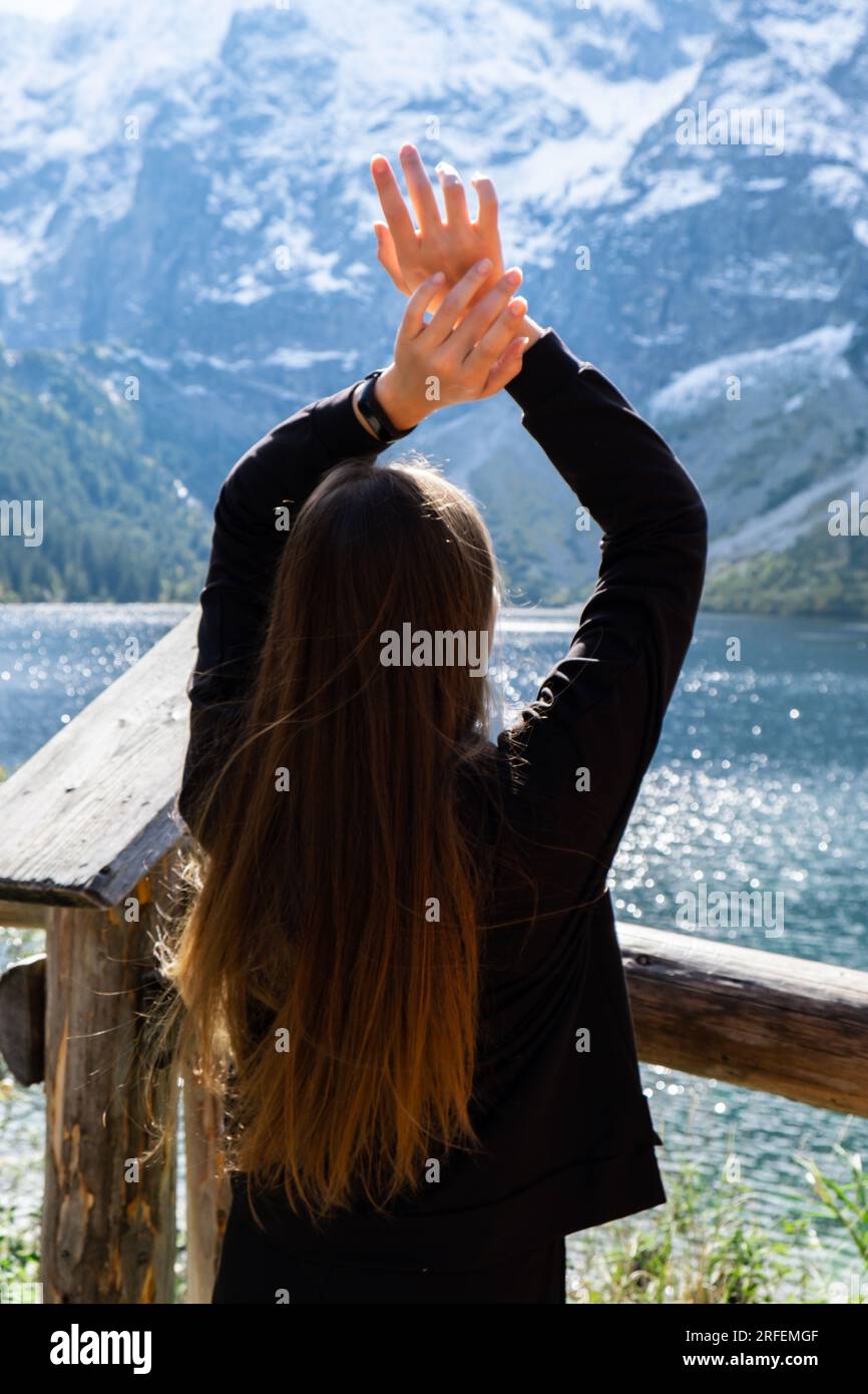 Young woman enjoying nature in Morskie Oko Snowy Mountain Hut in Polish ...