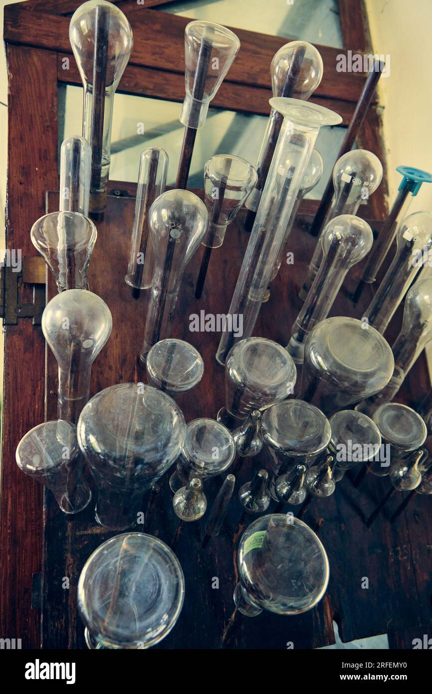 Glass bottles, test tubes, flasks and cups in an old chemical ...