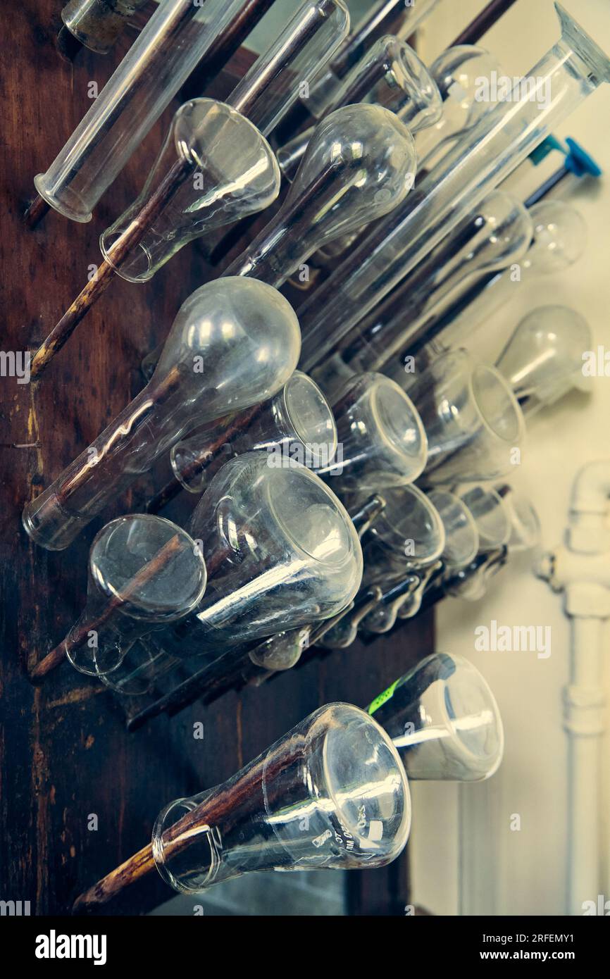 Glass bottles, test tubes, flasks and cups in an old chemical ...