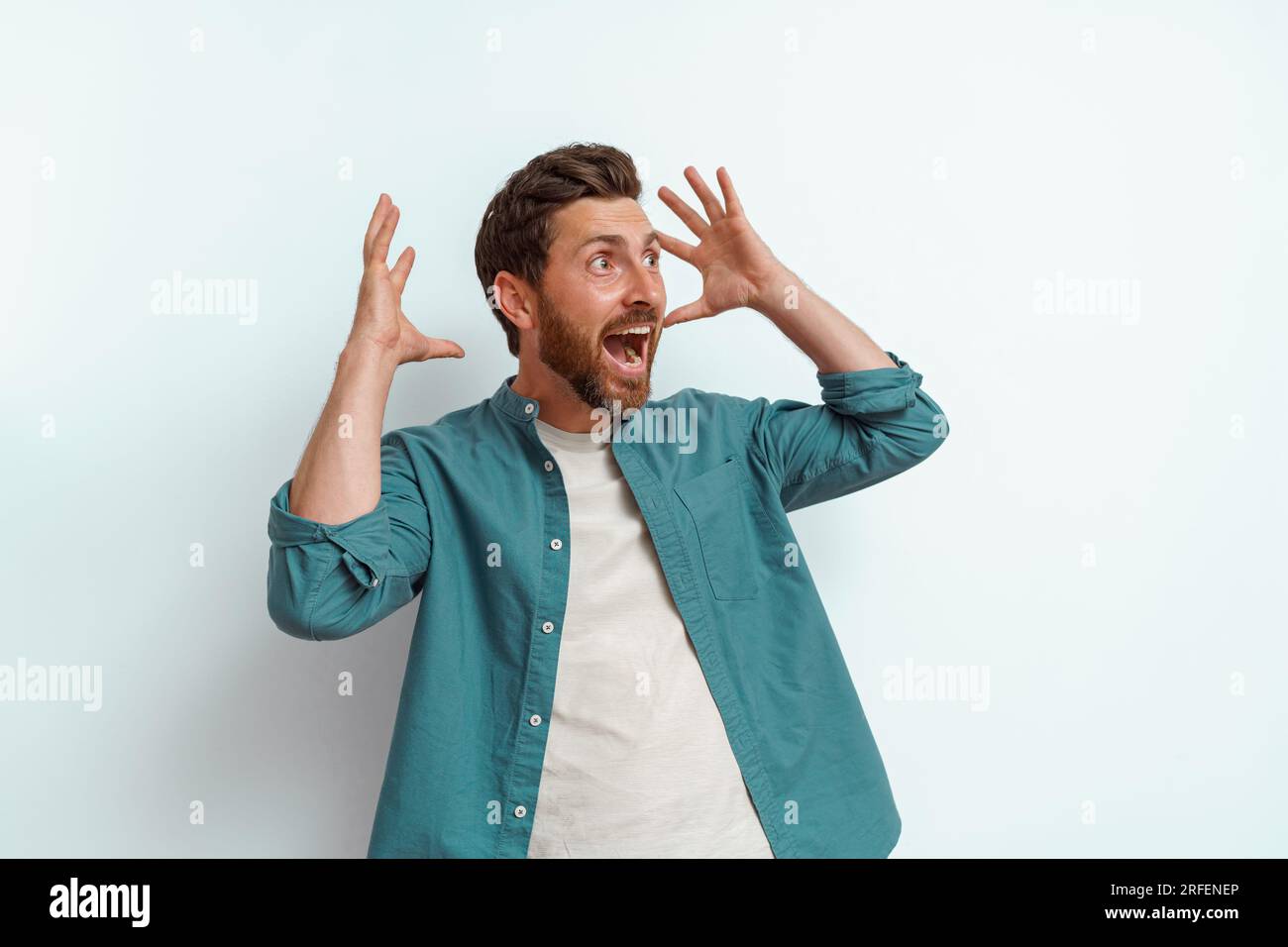 Surprised and shocked man standing on white background and screaming ...