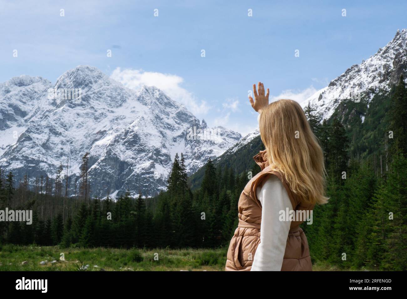 Young woman enjoying nature in Morskie Oko Snowy Mountain Hut in Polish ...