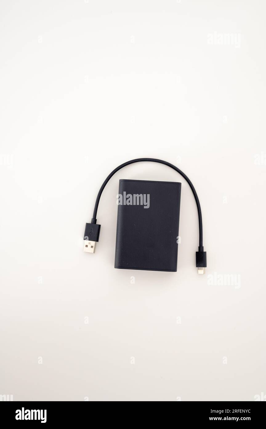 Black power bank with black cord cable isolated. White background Stock ...