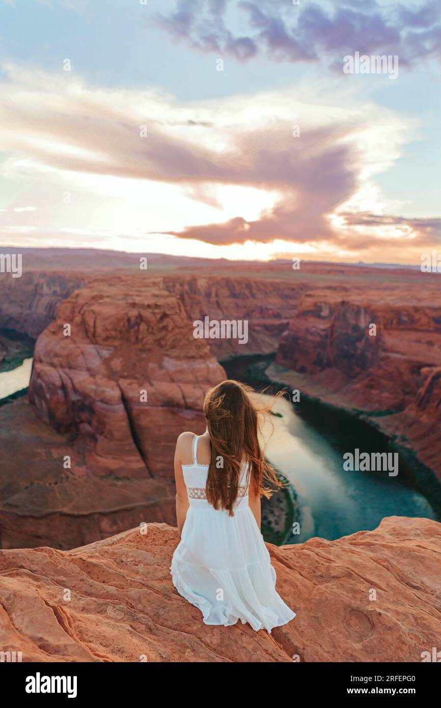 Happy girl on the edge of the cliff at Horseshoe Band Canyon in Page ...