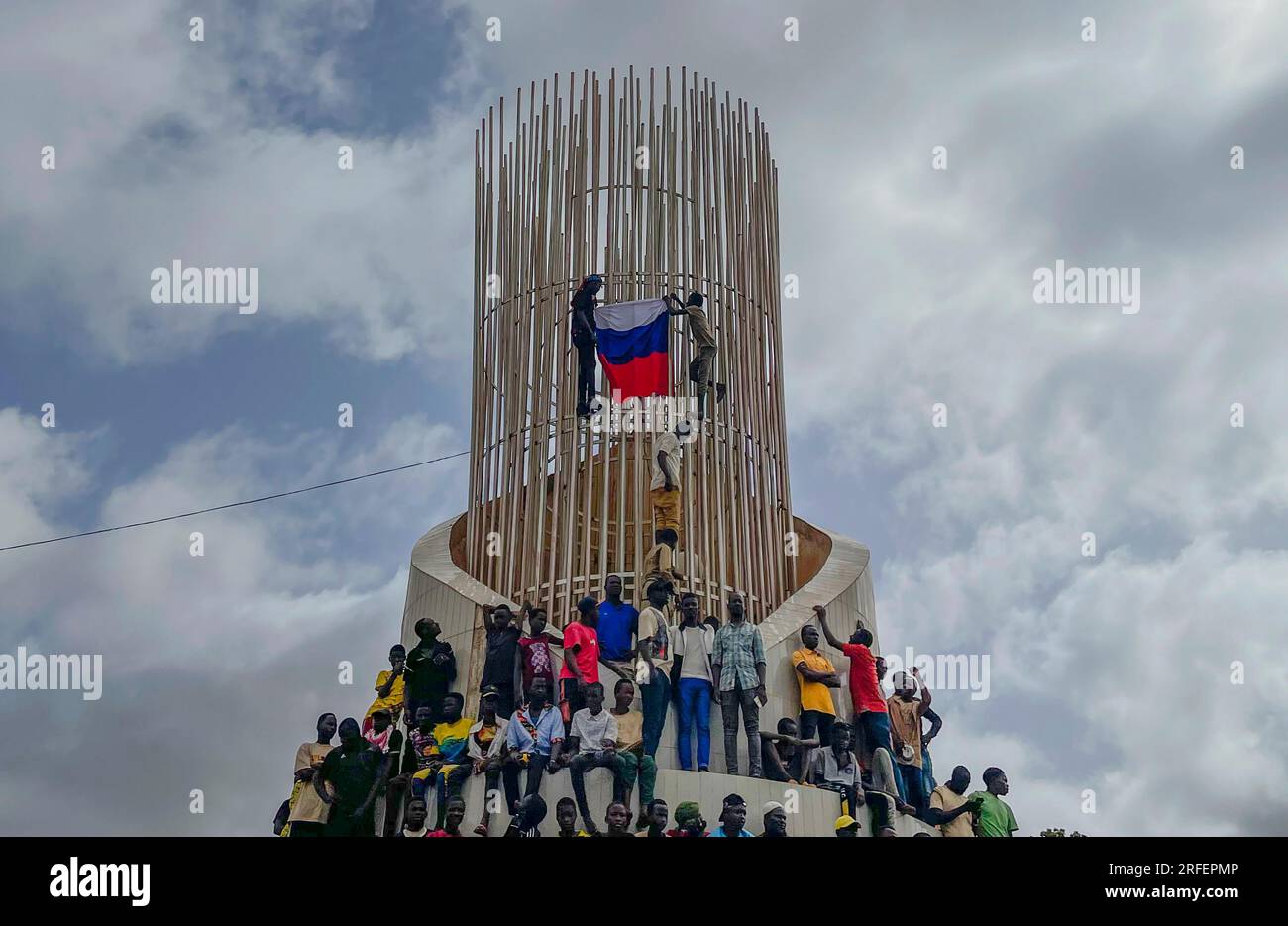 Supporters of Niger's ruling junta hold a Russian flag at the start of ...