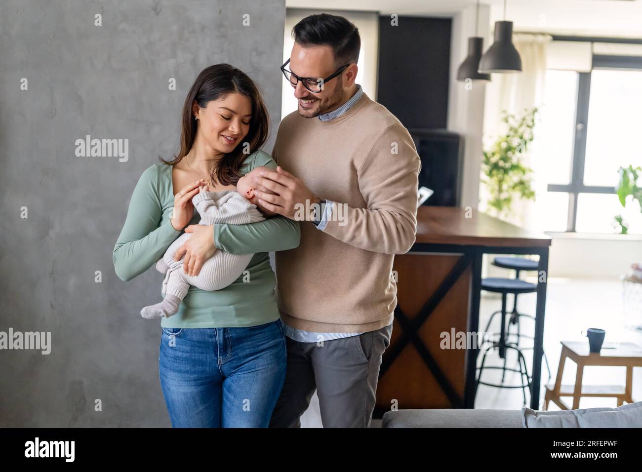 Peaceful young married couple enjoying being family, parents, holding ...