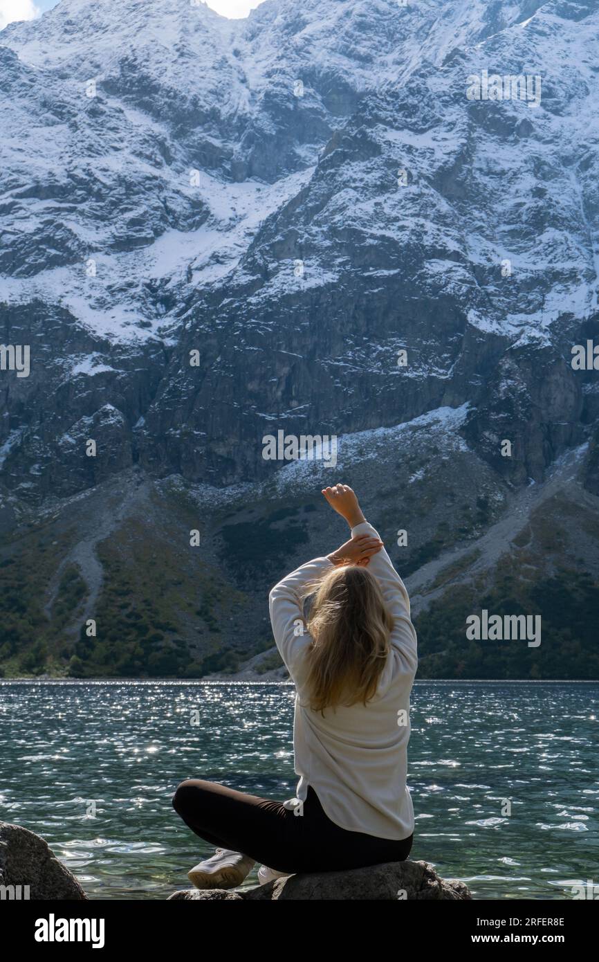Young woman enjoying nature in Morskie Oko Snowy Mountain Hut in Polish ...
