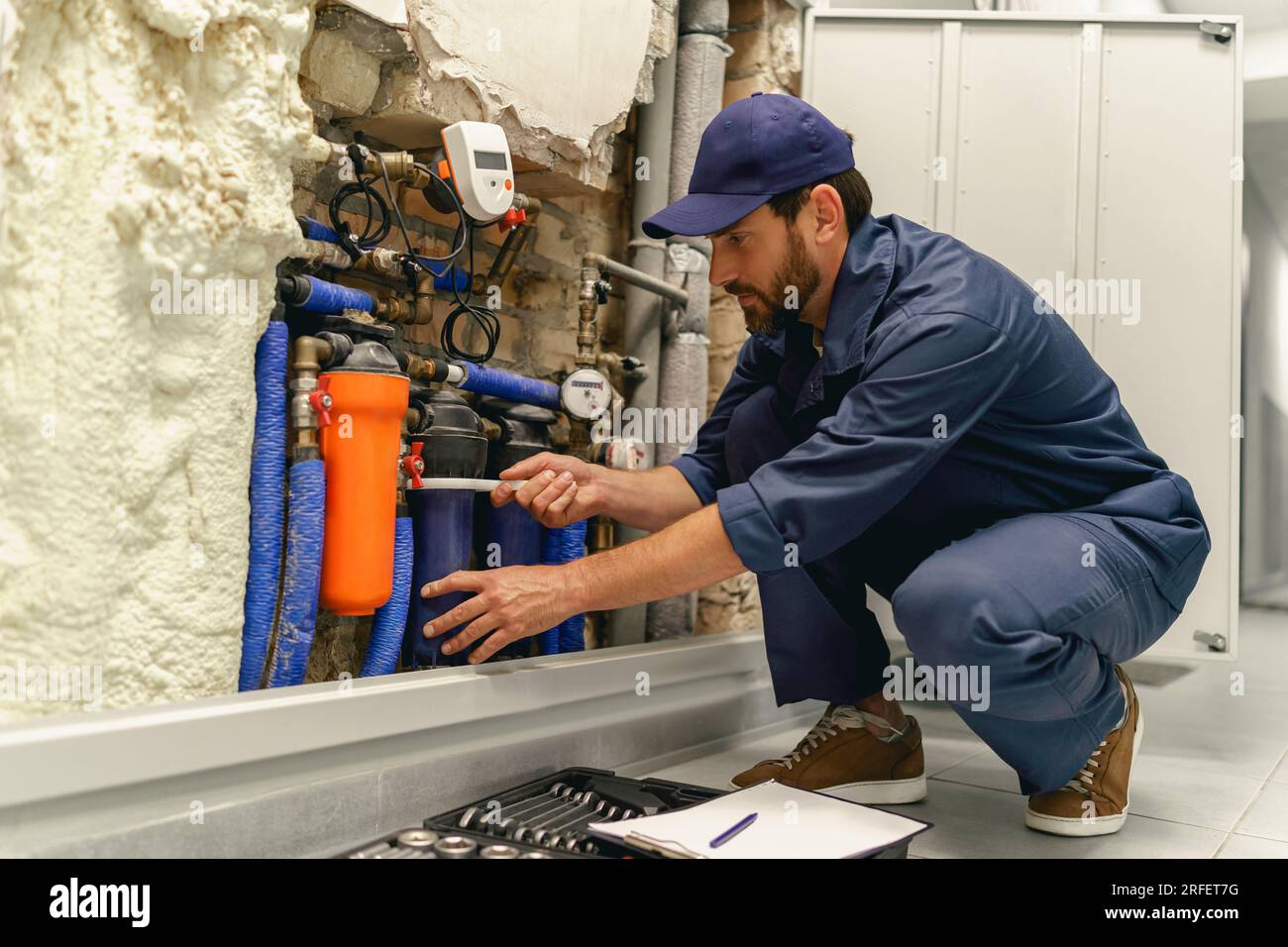 Professional plumber repairing water supply system at home uses an ...