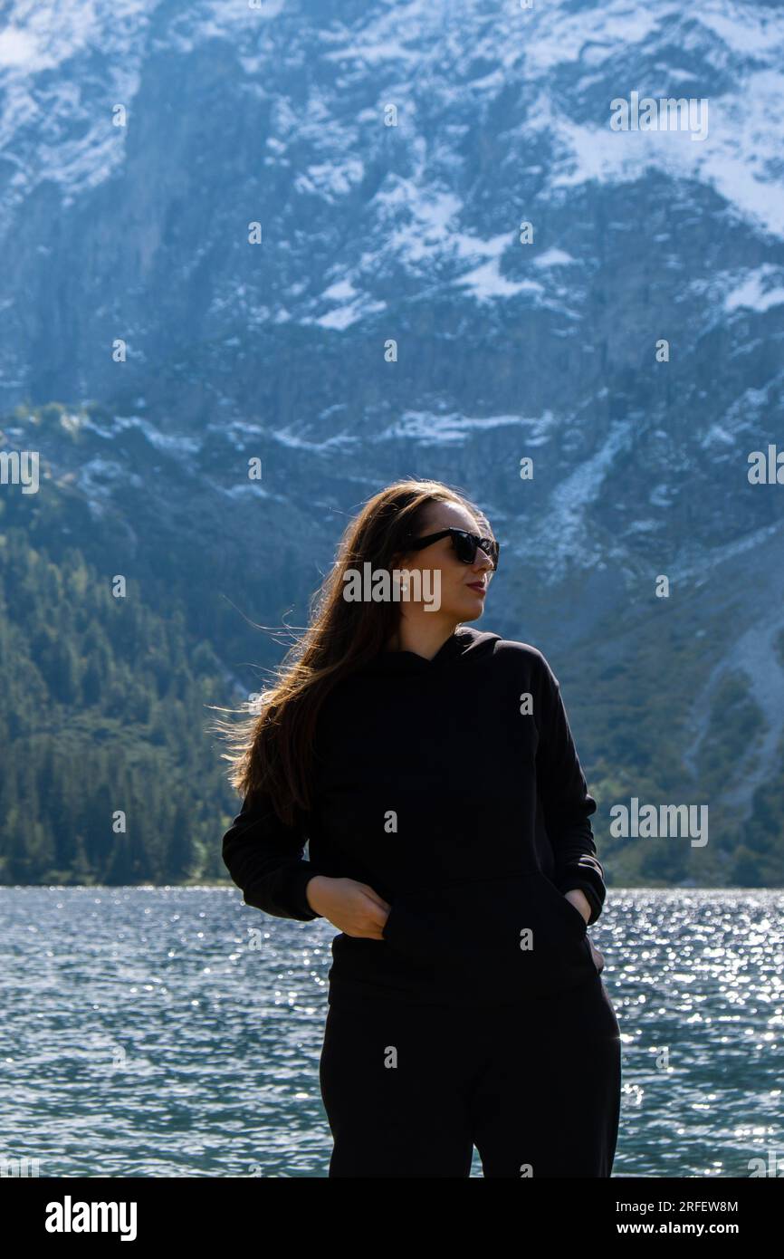 Young woman enjoying nature in Morskie Oko Snowy Mountain Hut in Polish ...