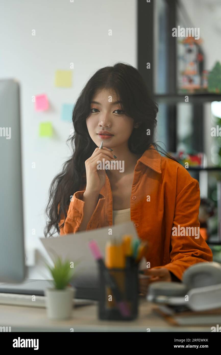 Young creative woman working with color palette, choosing color samples ...