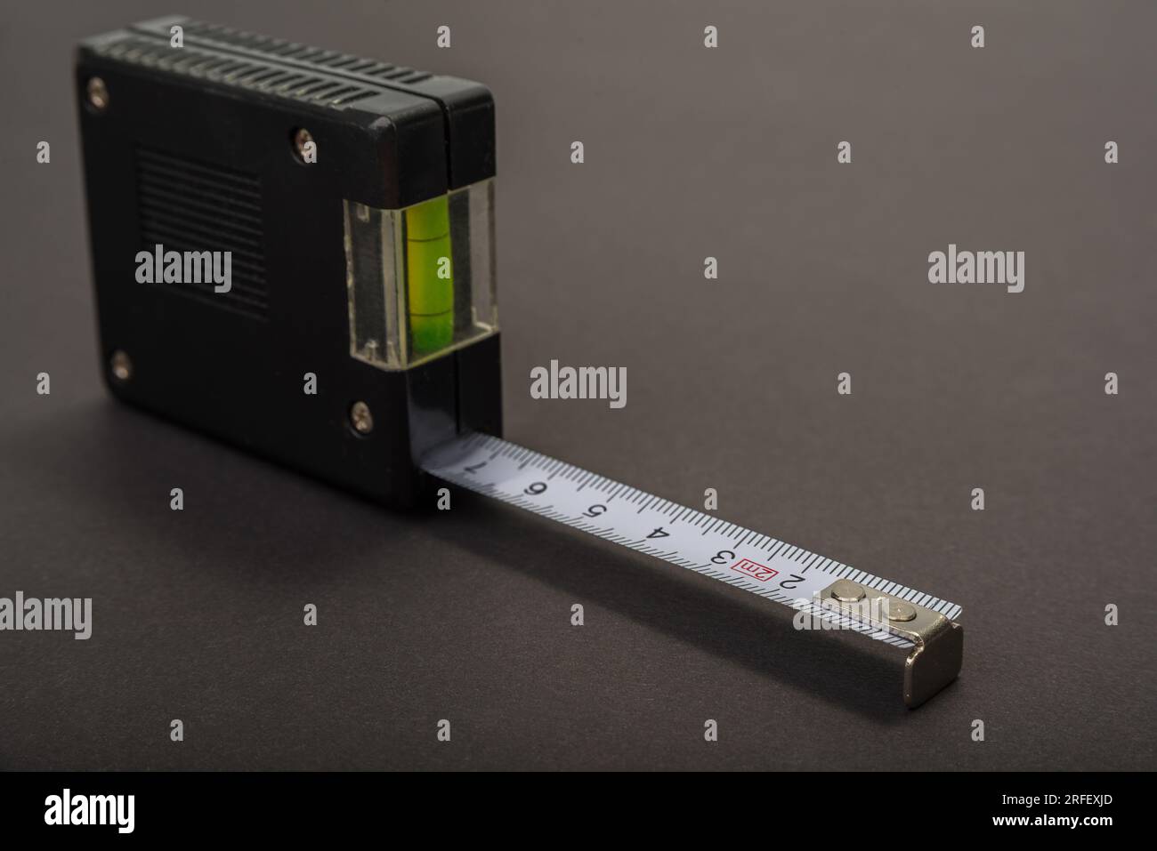 Spirit Level Tape Measures on a black Stock Photo - Alamy