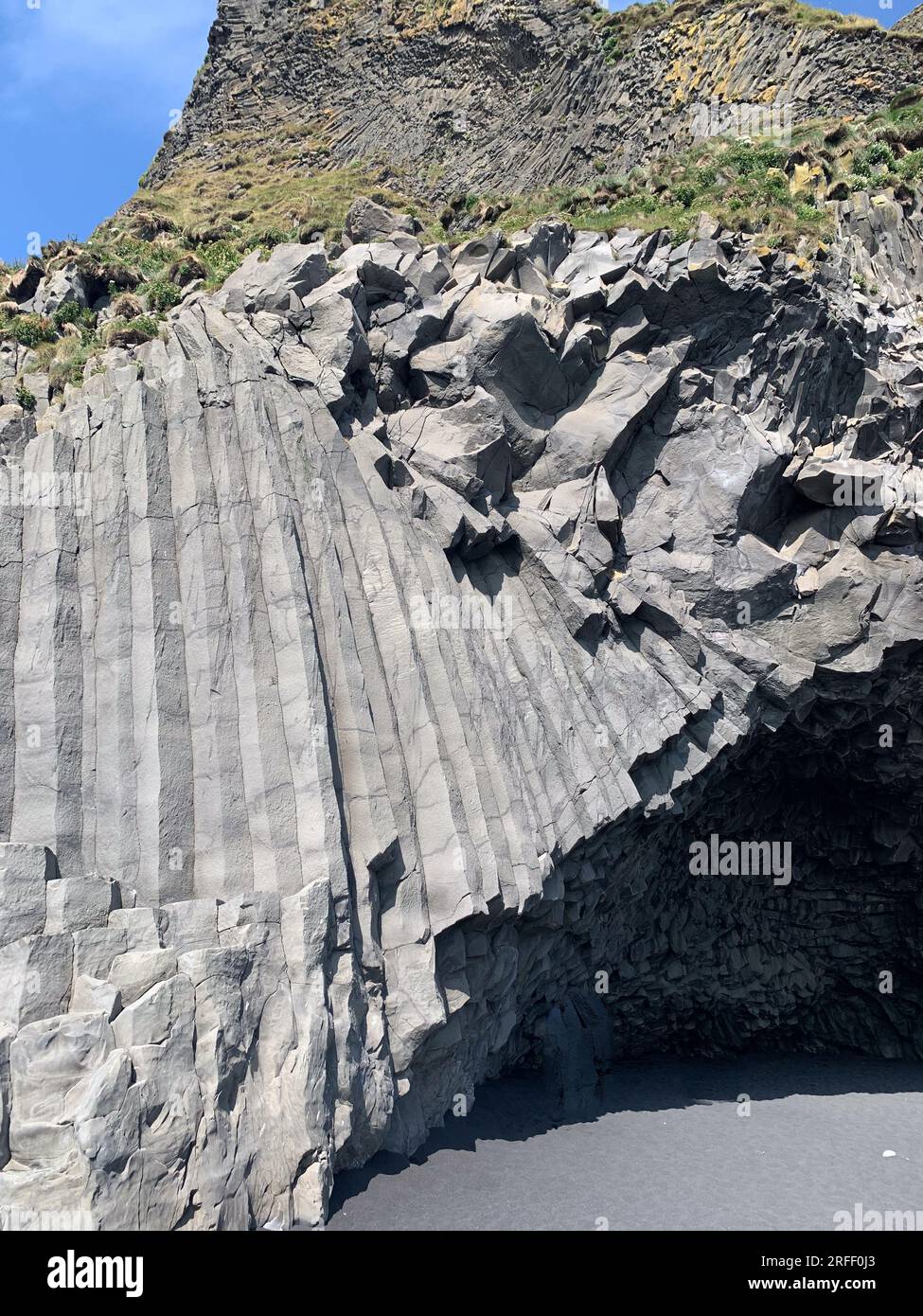 basalt columns at Reynisfjara, the famous black beach in Iceland, near Vík í Mýrdal, form a ...