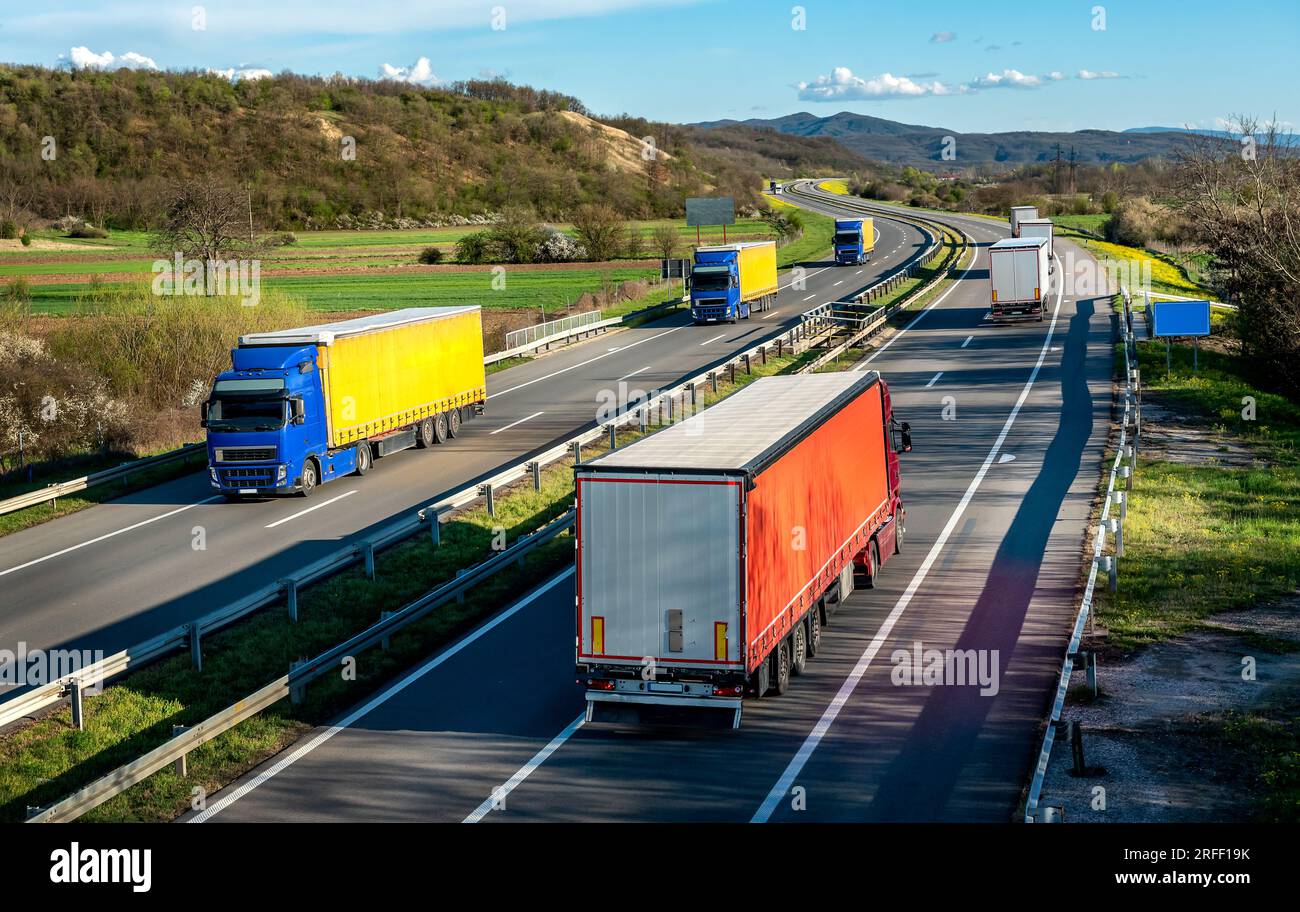 Convoys of transportation Trucks in lines passing each other on a rural ...