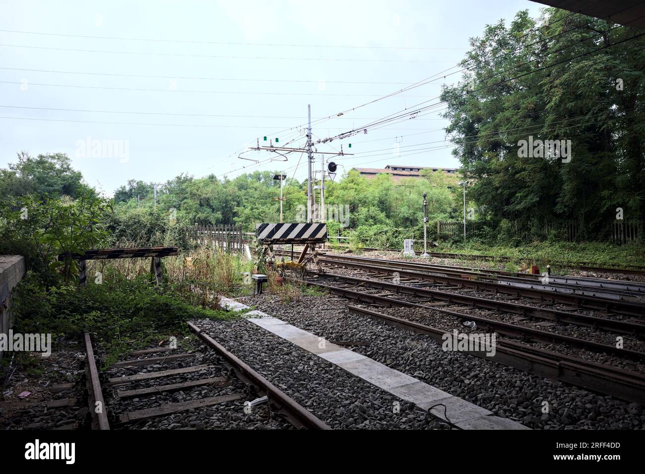 Dead end tracks on a railroad on a cloudy day in the italian ...