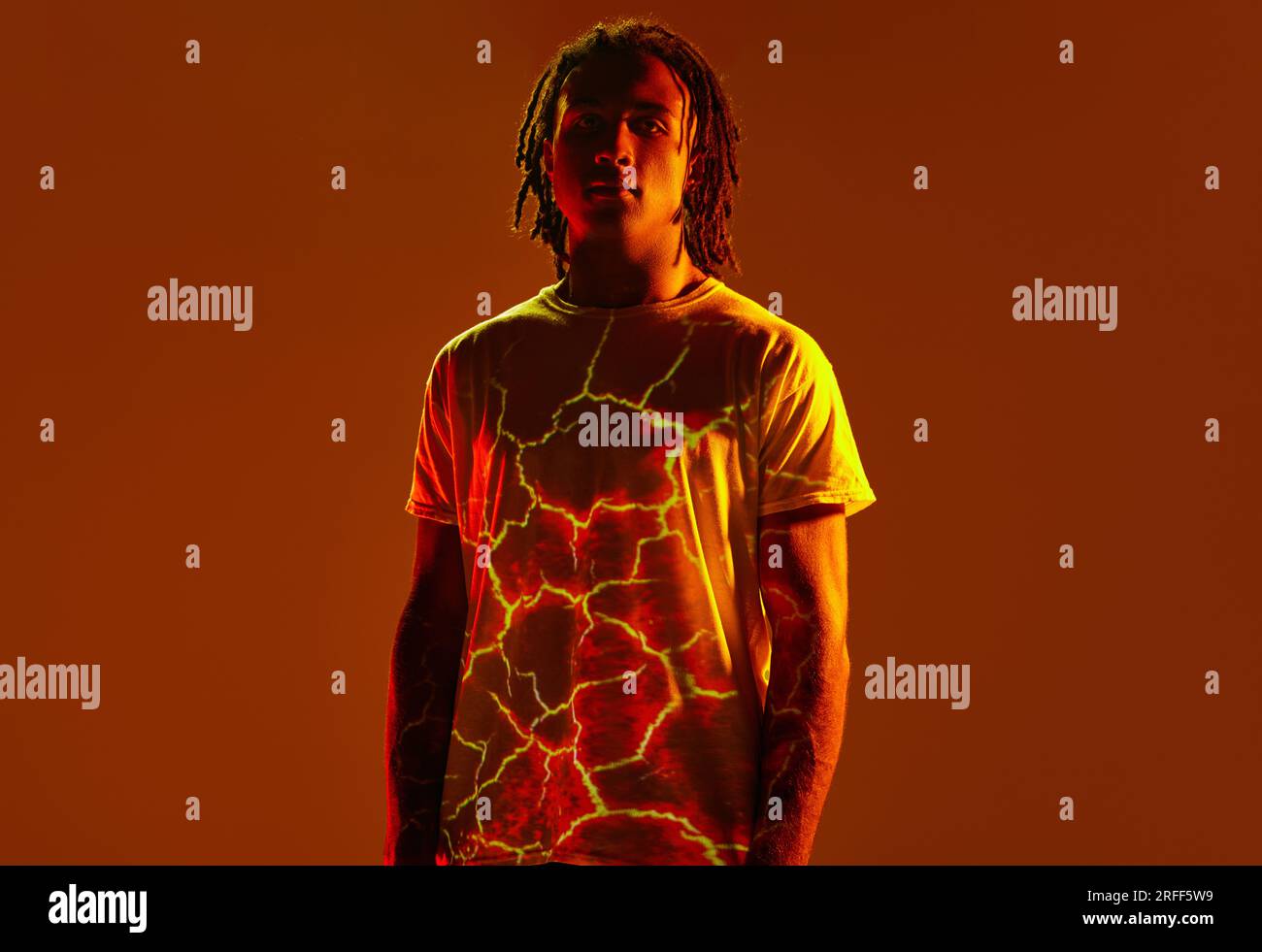 Creative portrait of young african man with digital fire light ...