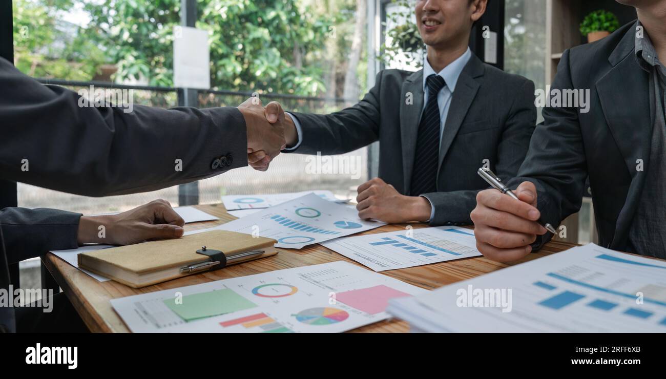 Young asia business shaking hands successful making a deal, business ...