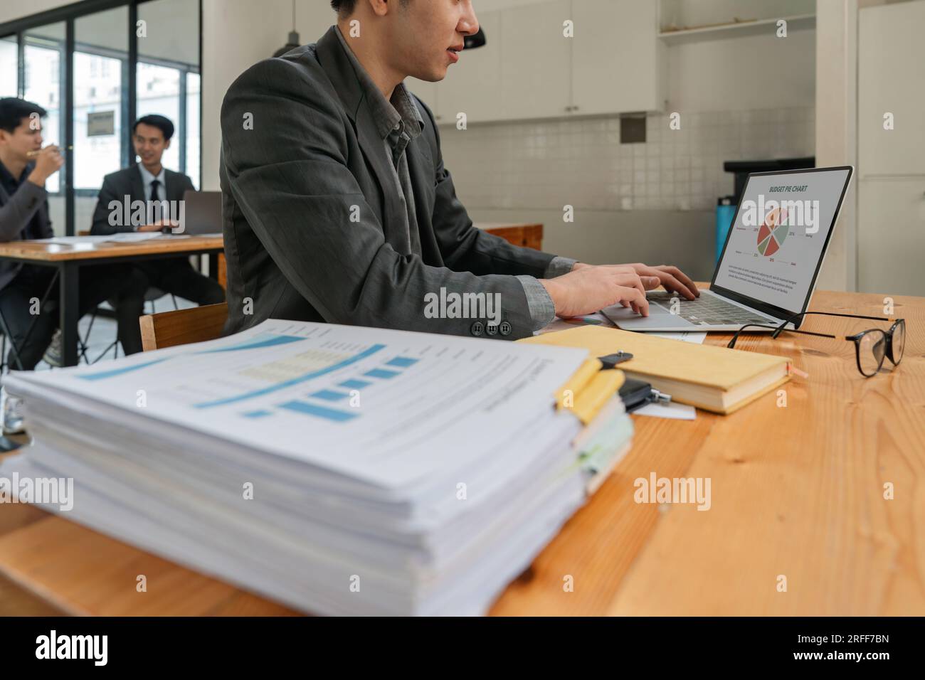 Young asian business man audit analysis graph company budget report ...