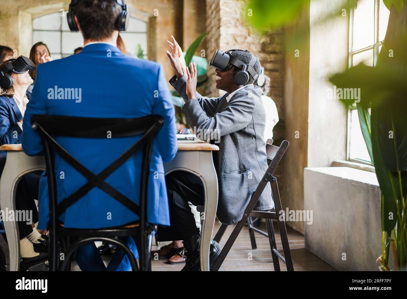 Teamwork colleagues using virtual reality headset inside business ...