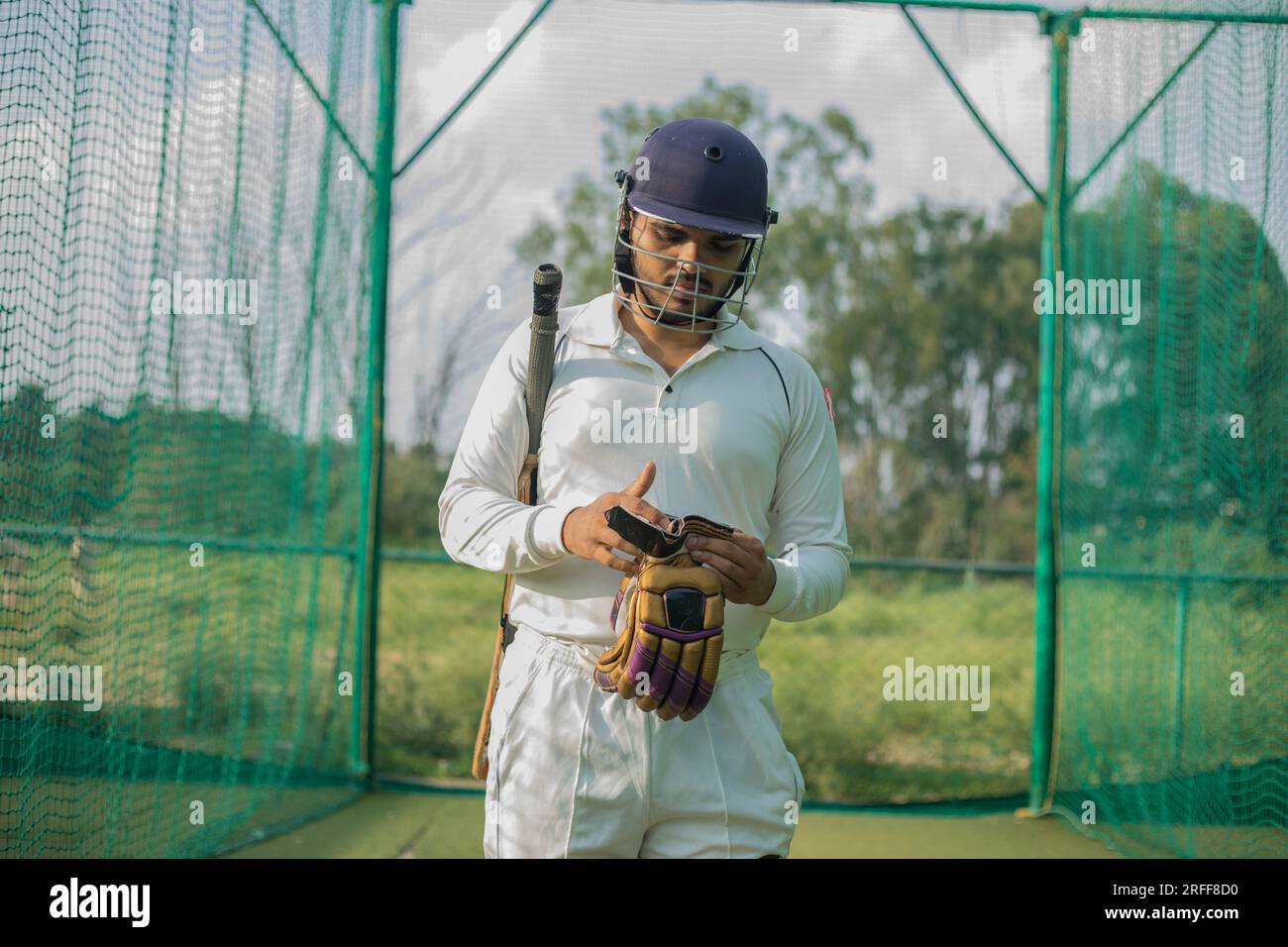 cricket player wearing hand gloves, ready to do practice in nets Stock ...