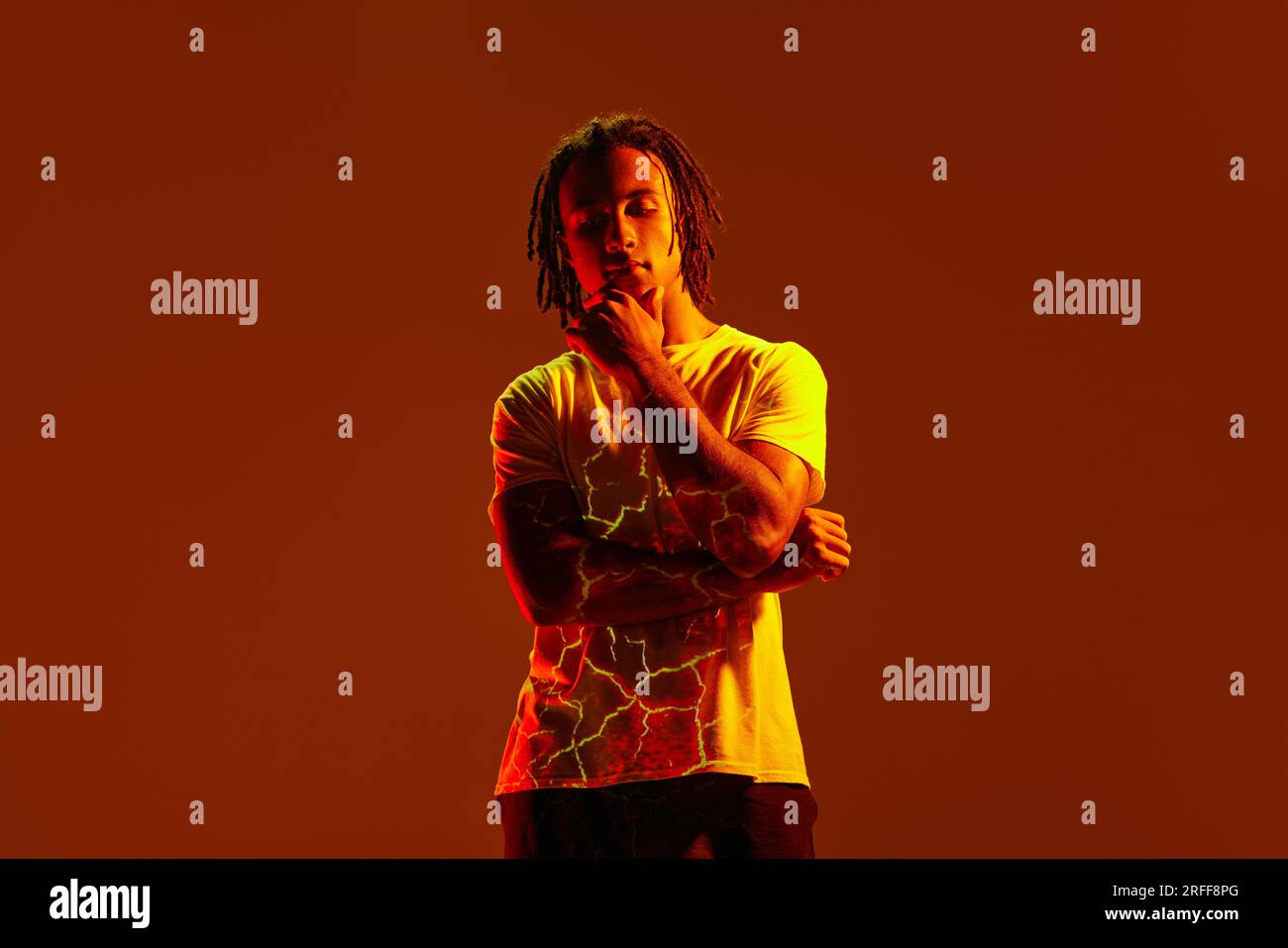 Handsome young african man with fire light reflection on body, hologram ...