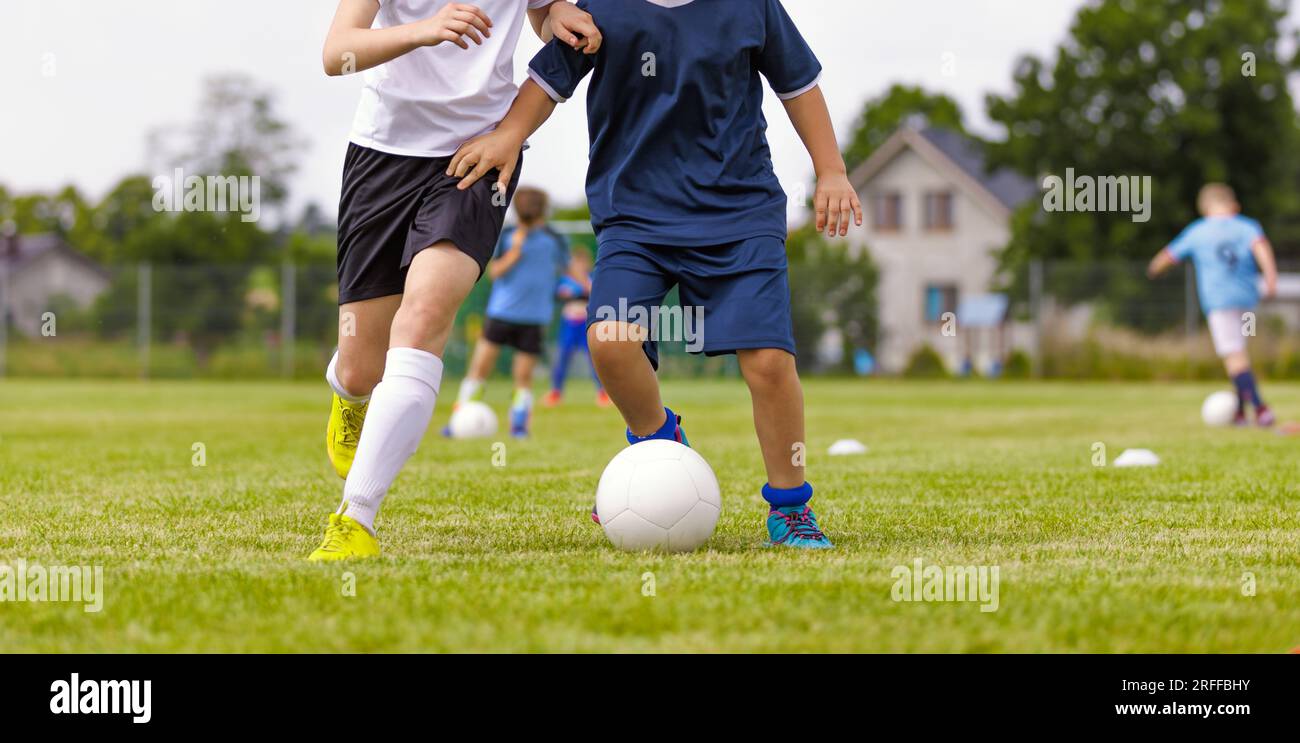 Legs of two young football players on a match. European football soccer ...