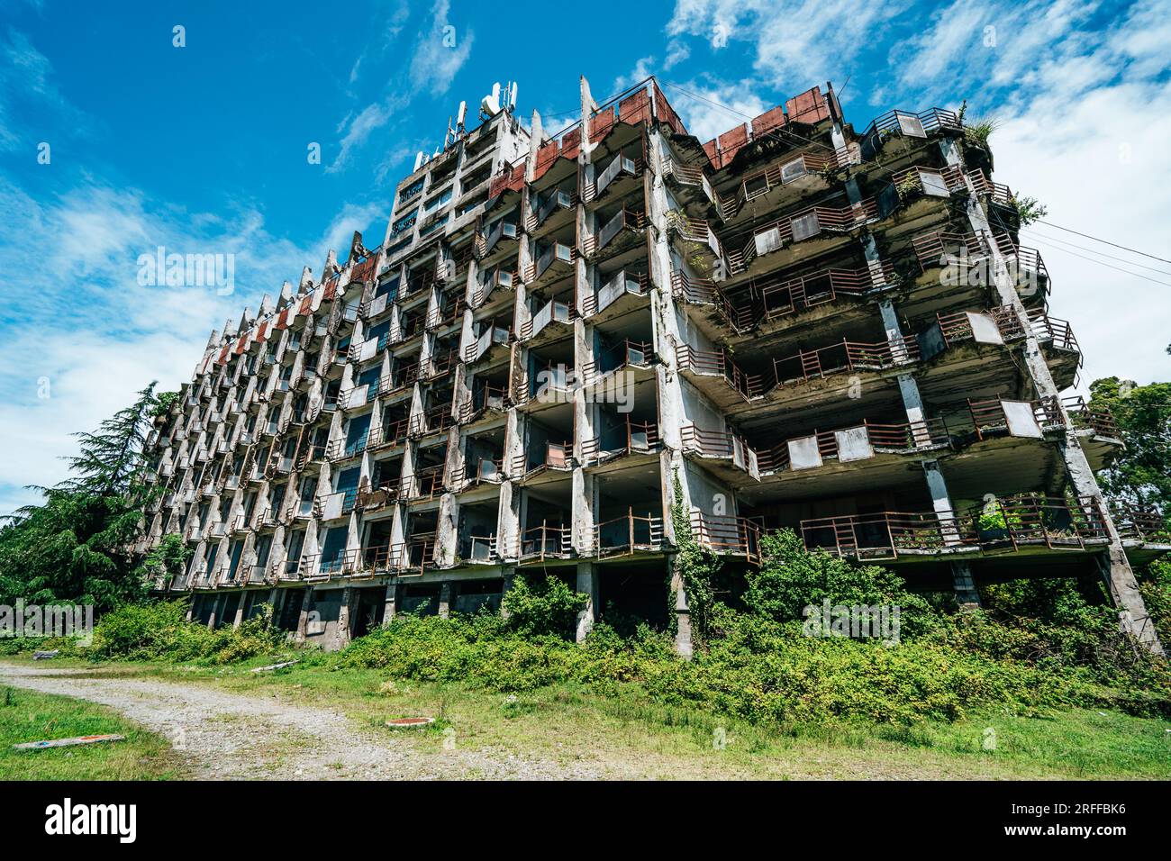 Large abandoned building overgrown with grass and plants. Urbex Lost ...