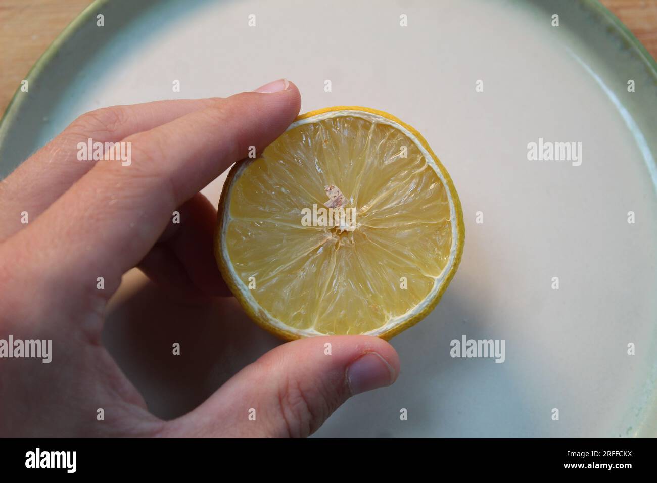 A close up photo of the inside of a lemon on a plate Stock Photo - Alamy
