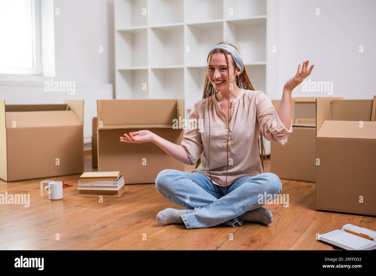 Modern ginger woman with braids moving into new apartment Stock Photo ...