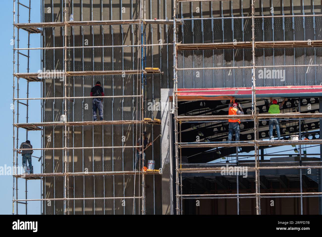 Workers on scaffolding at a construction site in Turkey Stock Photo - Alamy