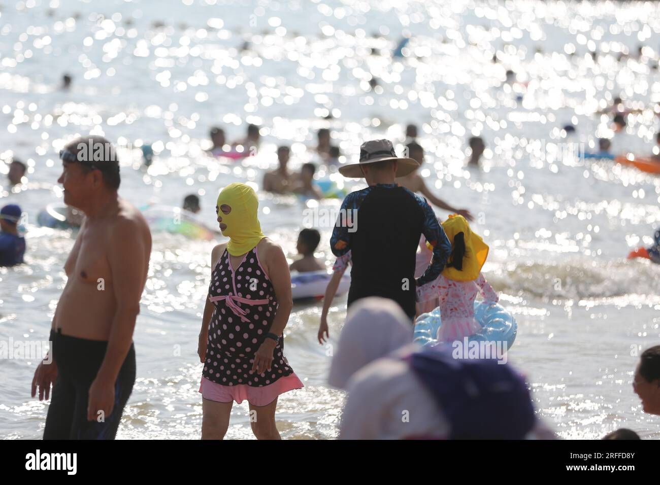 People enjoy summer time at the No 1 bathing beach in Qingdao City, east China's Shandong ...