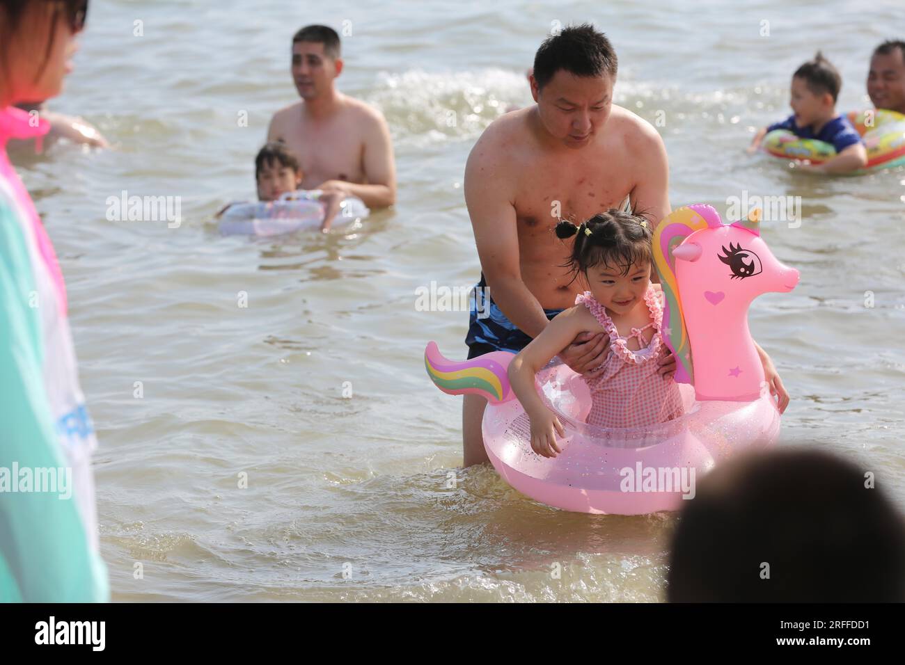 People enjoy summer time at the No 1 bathing beach in Qingdao City ...