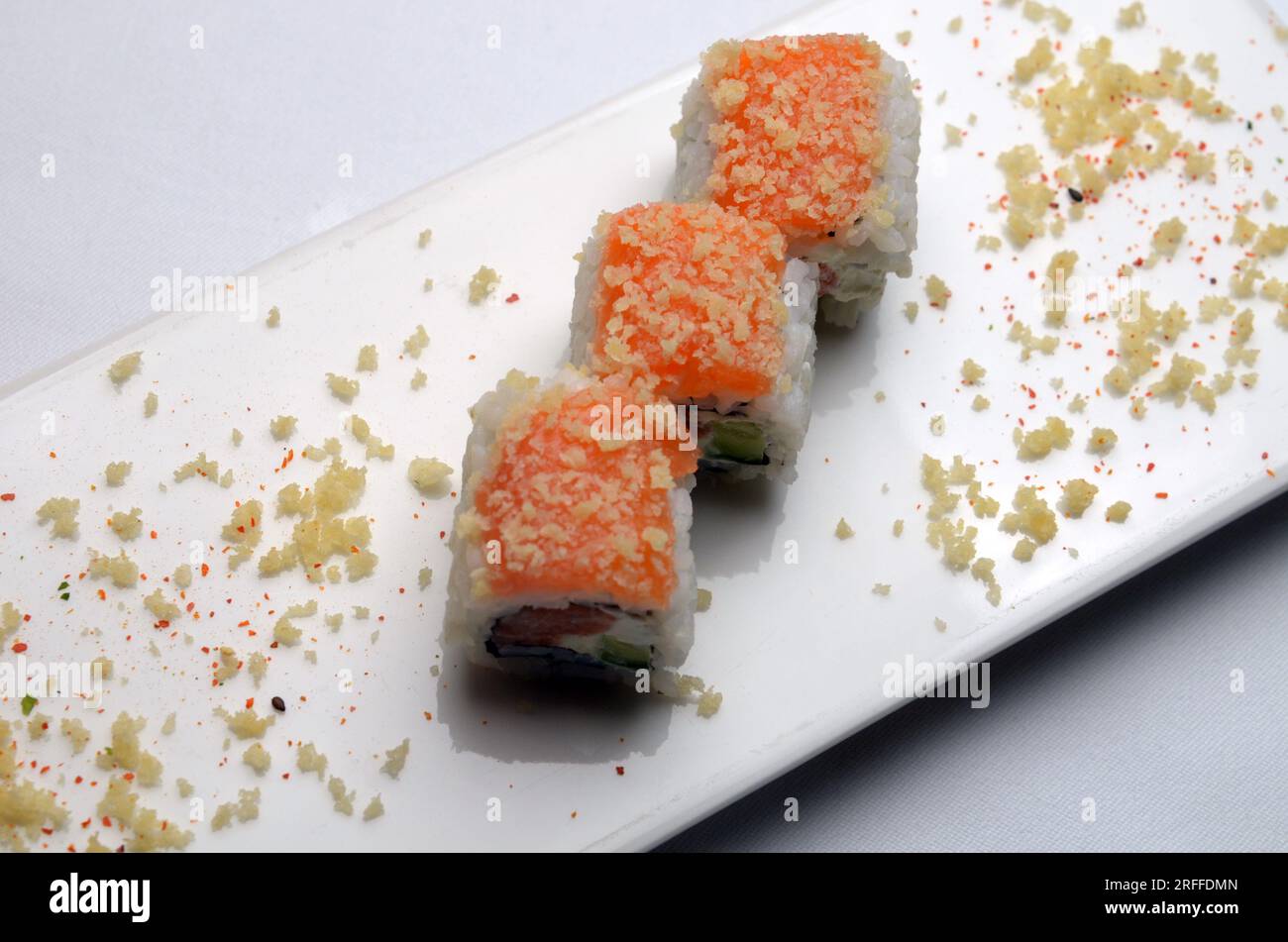 Sushi stuffed with rice and avocado wrapped in sea weed on a white ...