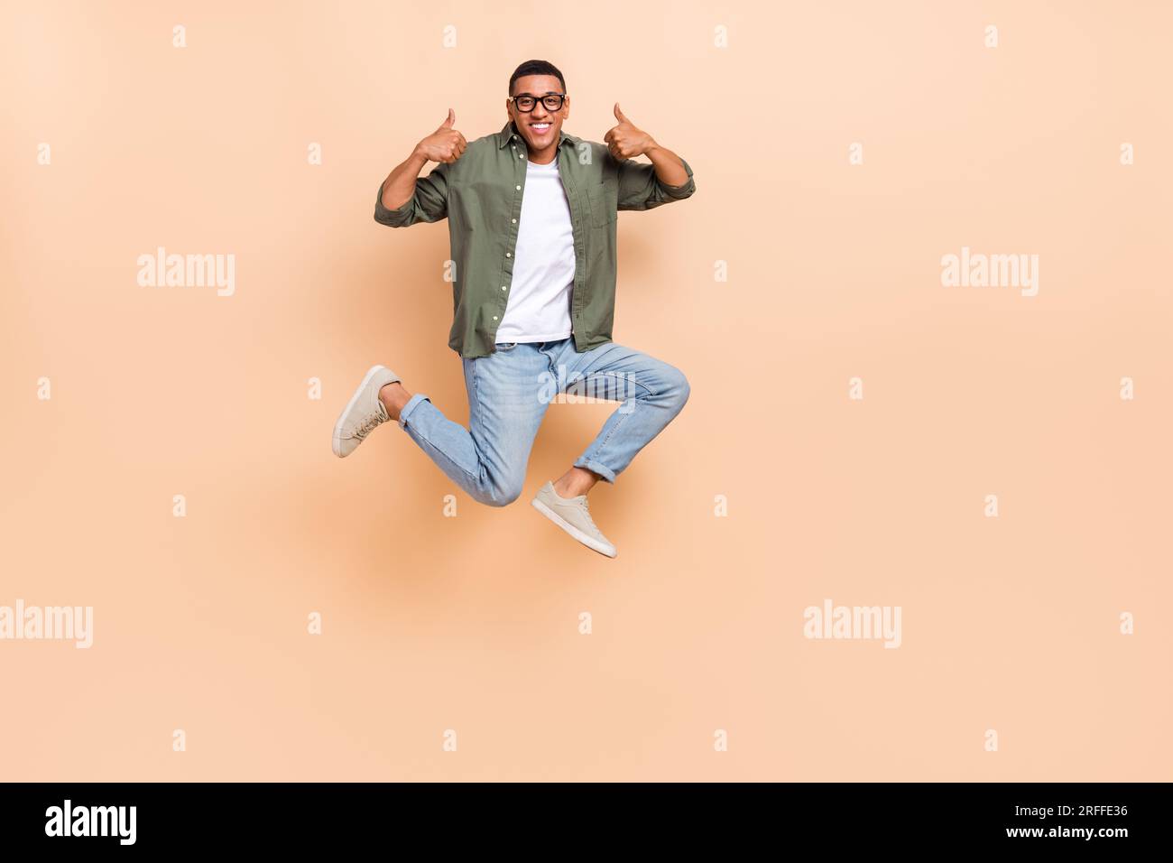 Full length portrait of excited man jumping hands fingers demonstrate ...