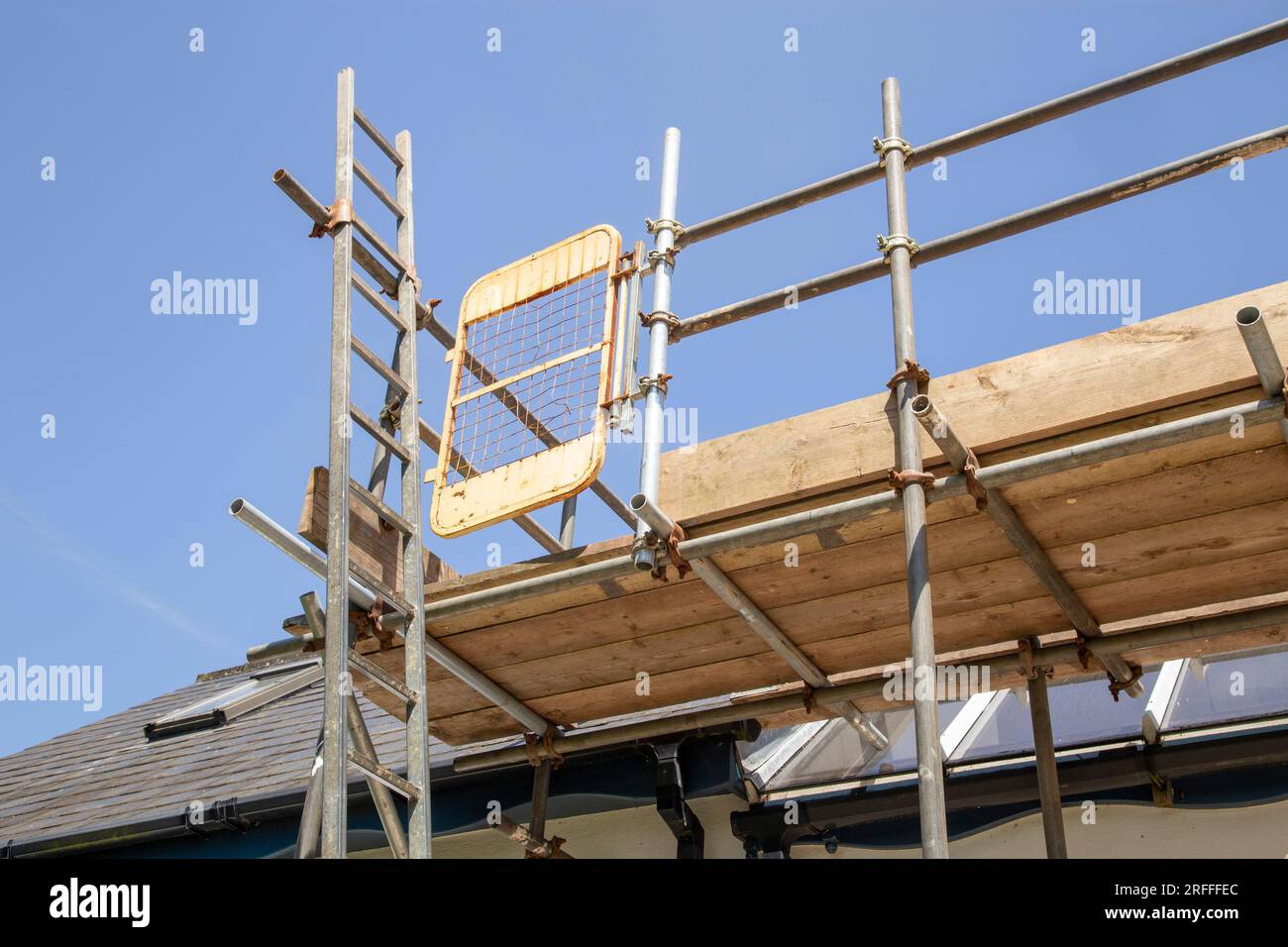 Scaffolding outside a house showing ladder, safety gate, edge boarding ...