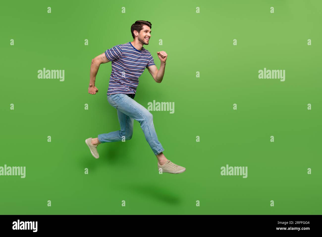 Full length photo of excited positive guy wear striped t-shirt running ...
