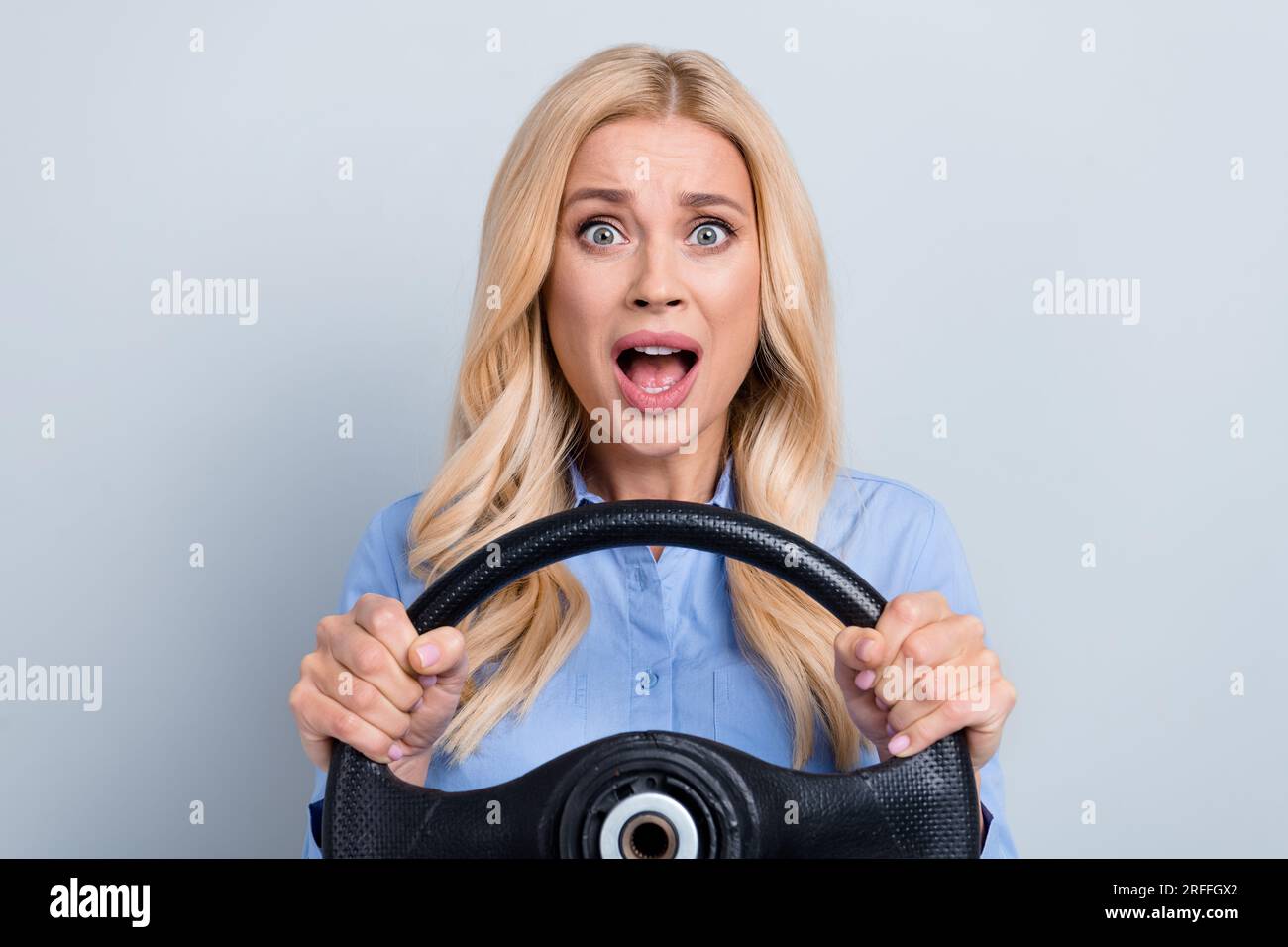 Photo of impressed confused lady open mouth scream arms hold steering ...