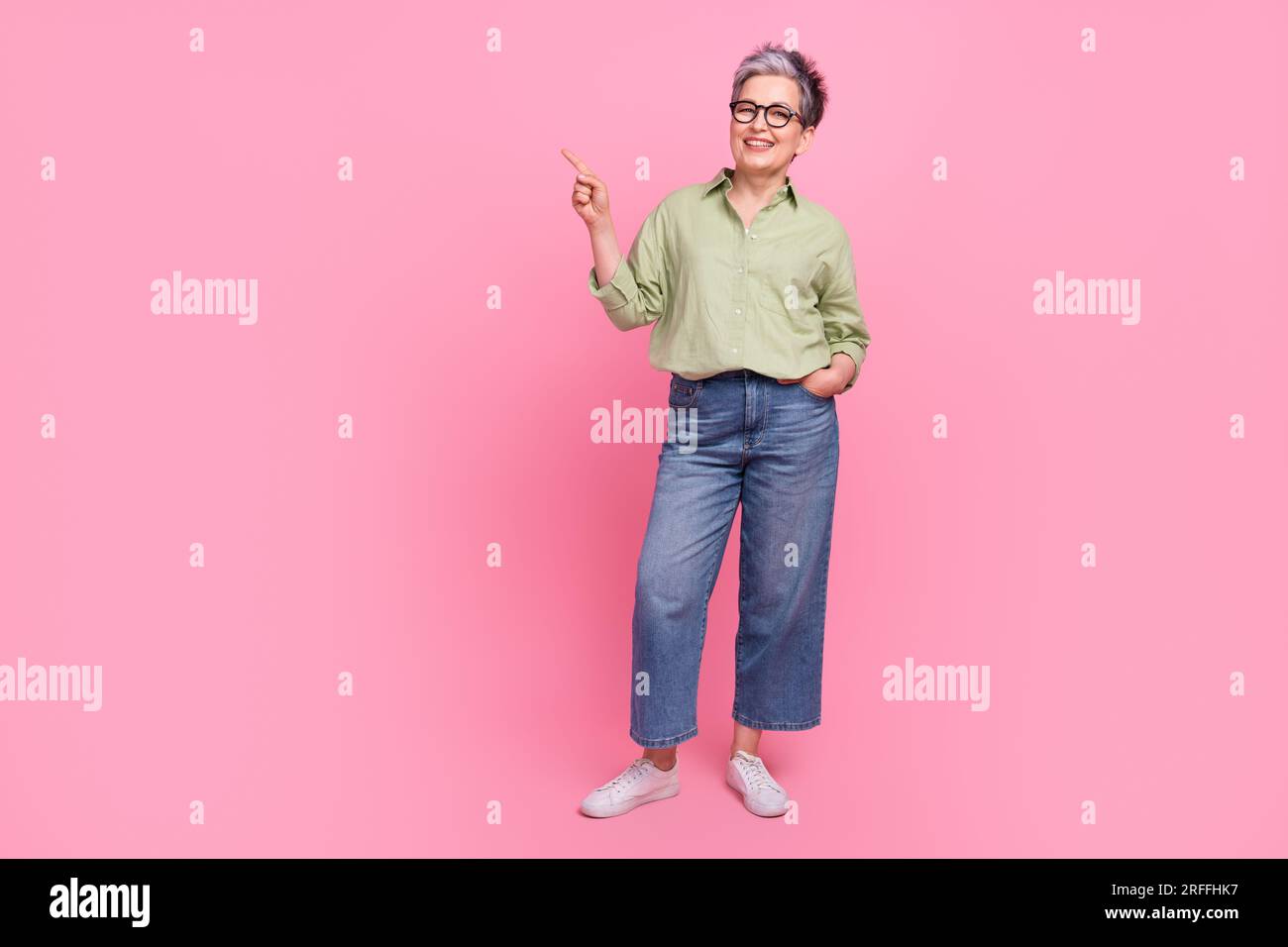 Full size portrait of positive nice person indicate finger empty space ...