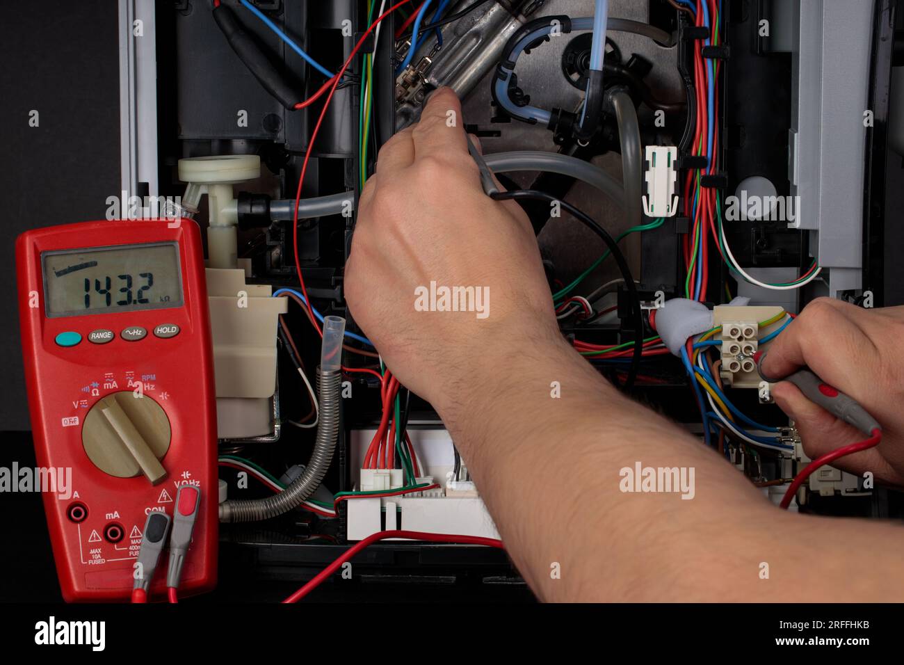 A close-up concept of repairing household appliances, focusing on a ...
