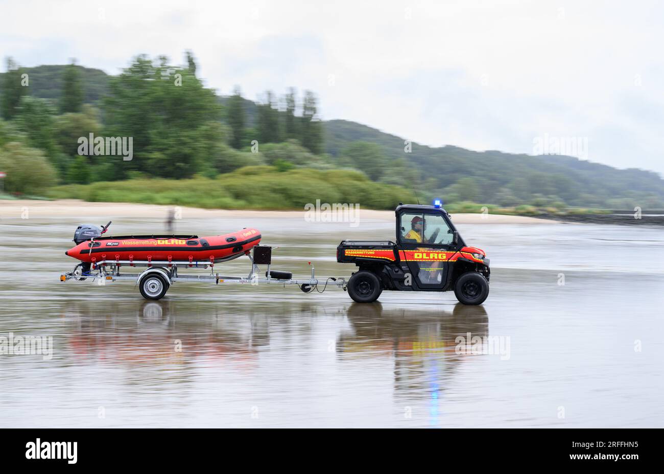 Hamburg, Germany. 03rd Aug, 2023. A DLRG vehicle drives along the Elbe ...